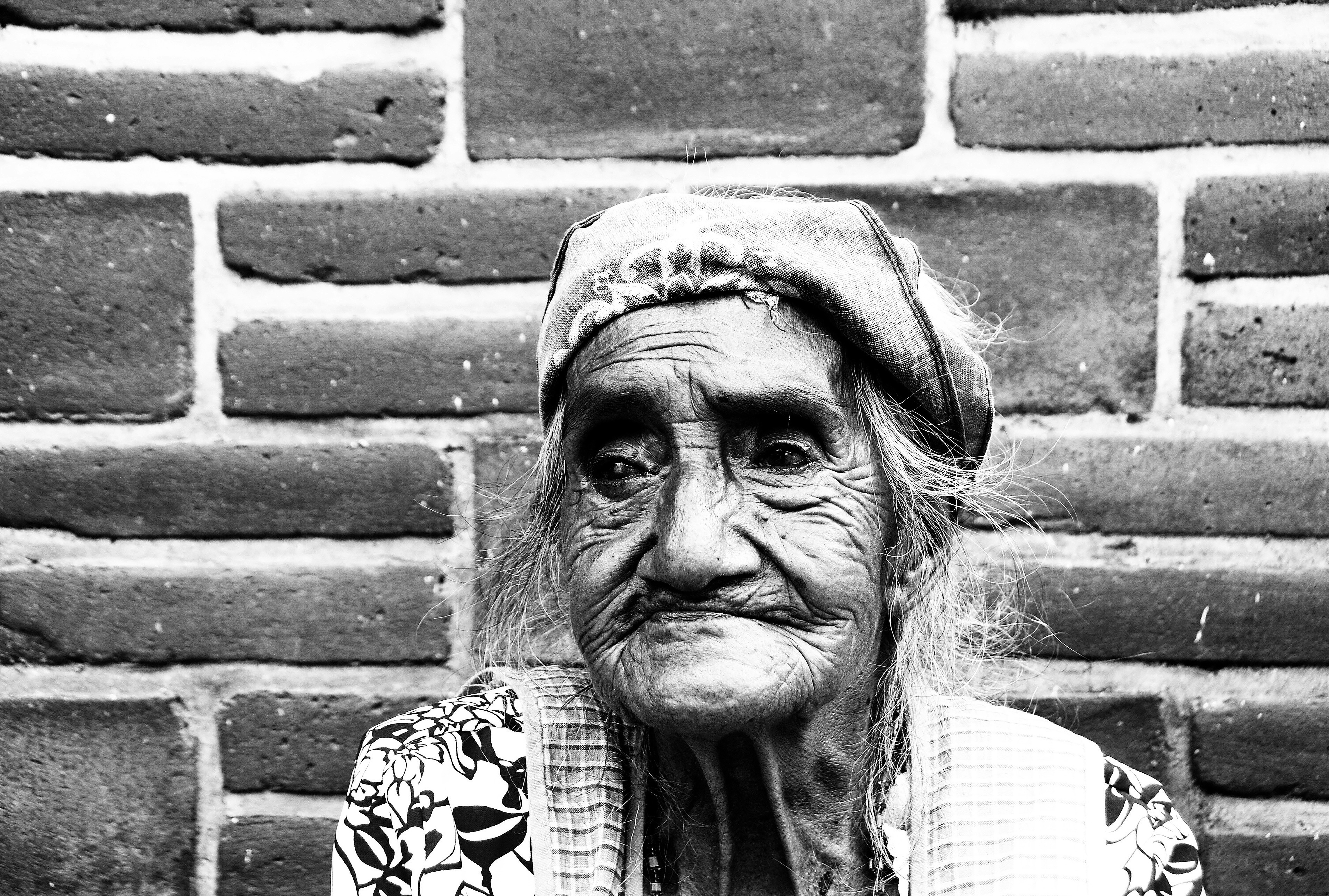 Weathered Wisdom: Portrait of an Elder in Velvet and Brick