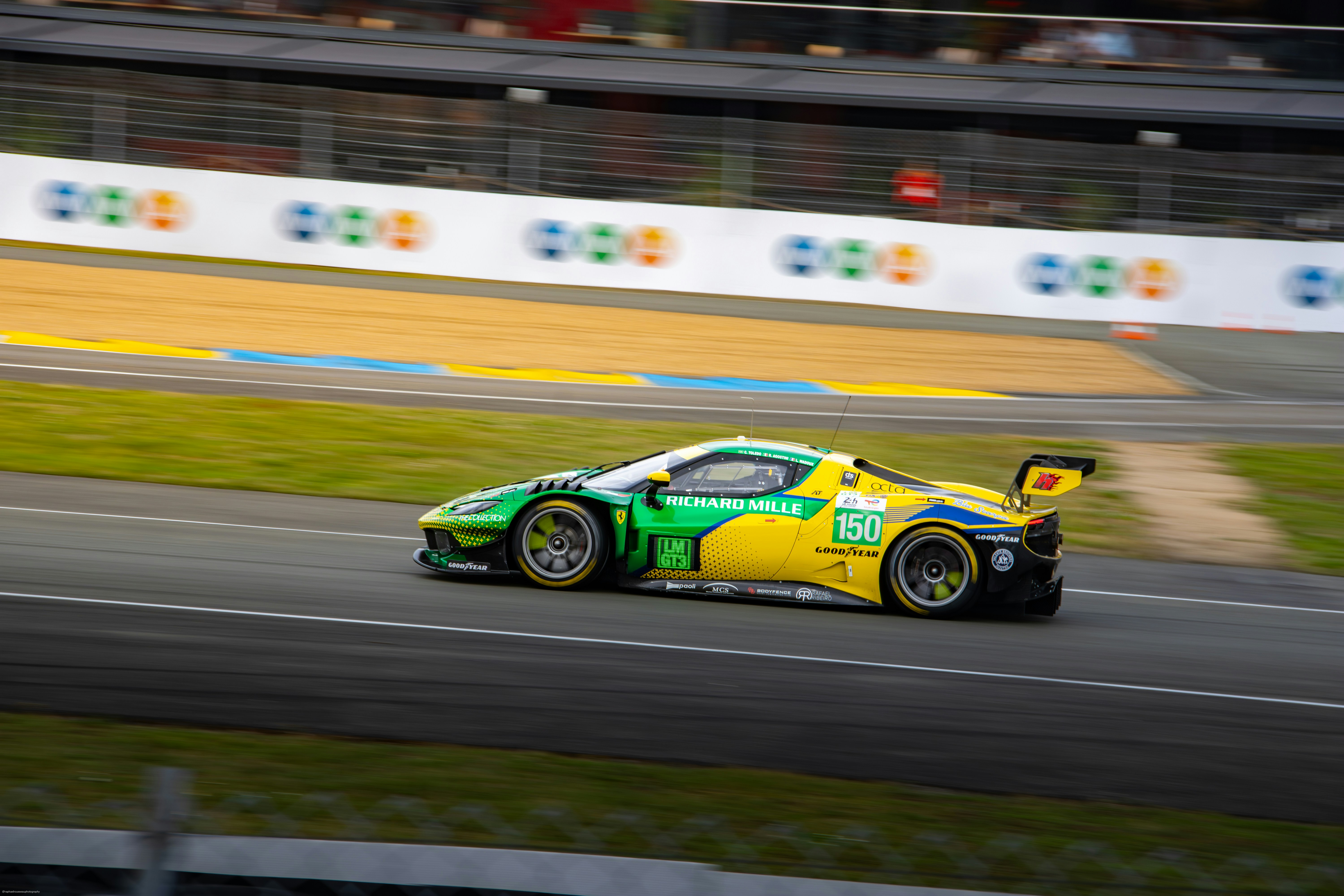 Yellow-green racecar in motion on a blurred track