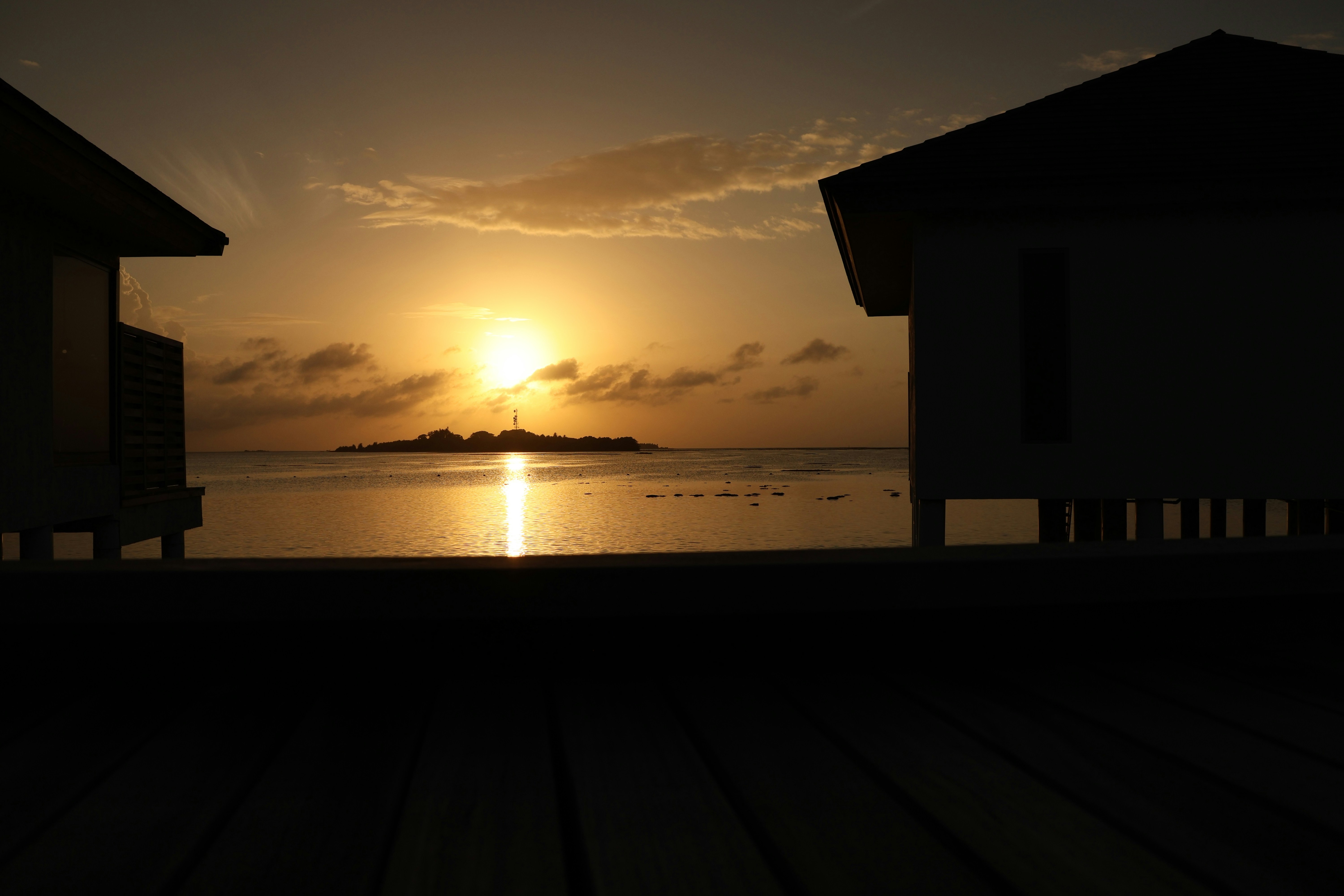 Sunset Silhouette Between Lagoon-facing Cabins