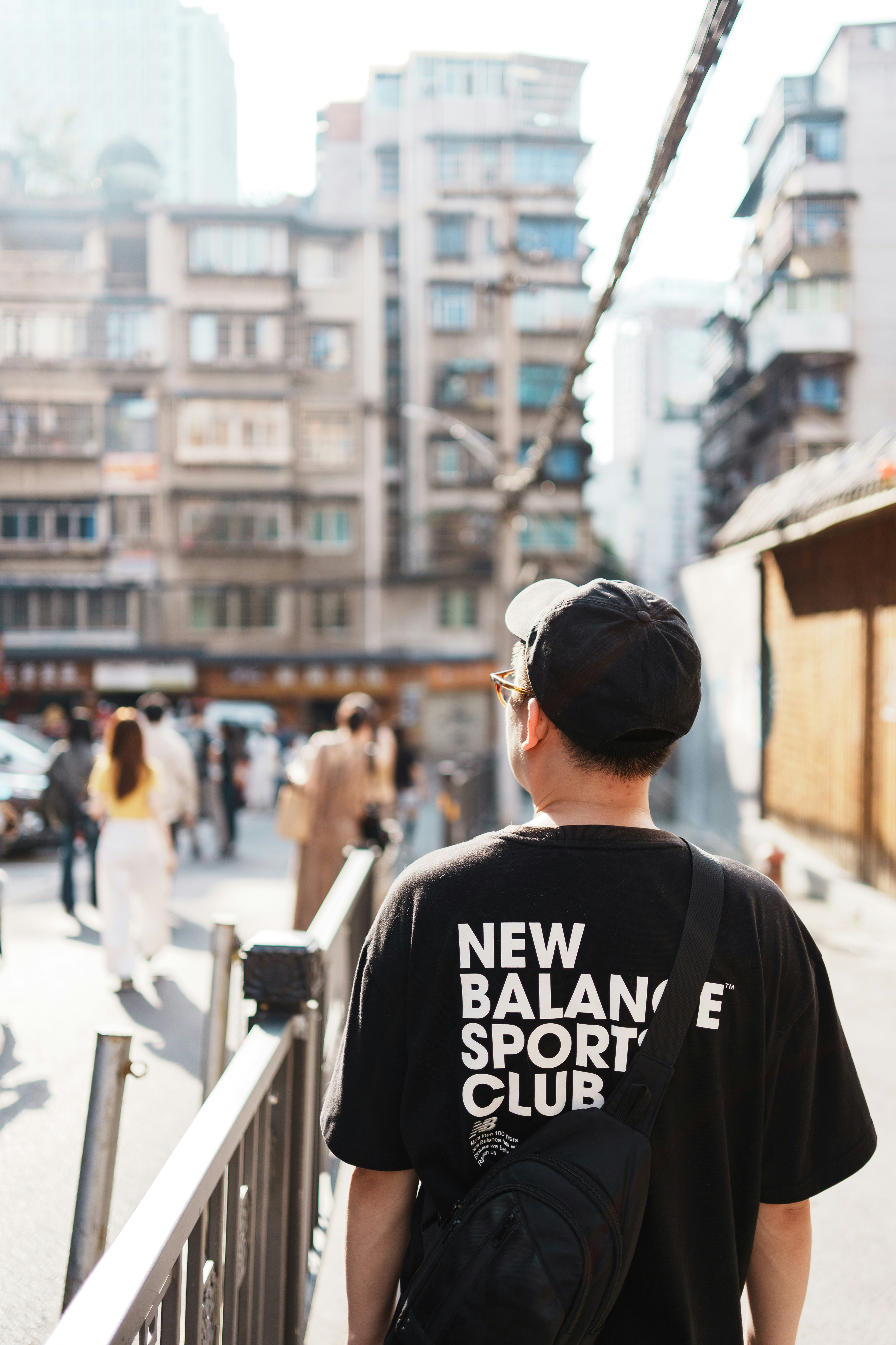Back to the Street: Focus on a Traveler in a Sunlit City