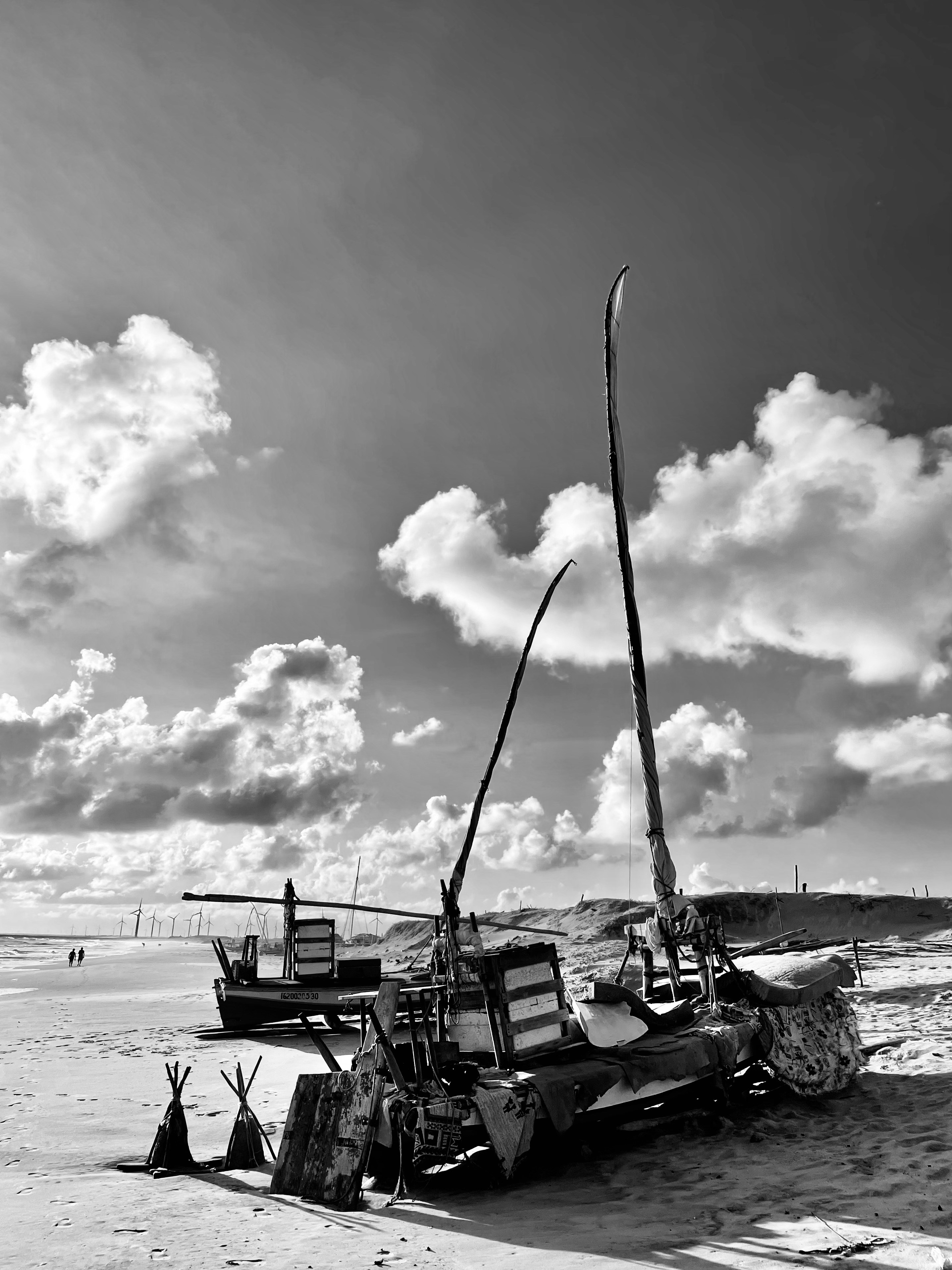 Wreckage on the Shore: Silent Geometry Beneath a Sky of Clouds