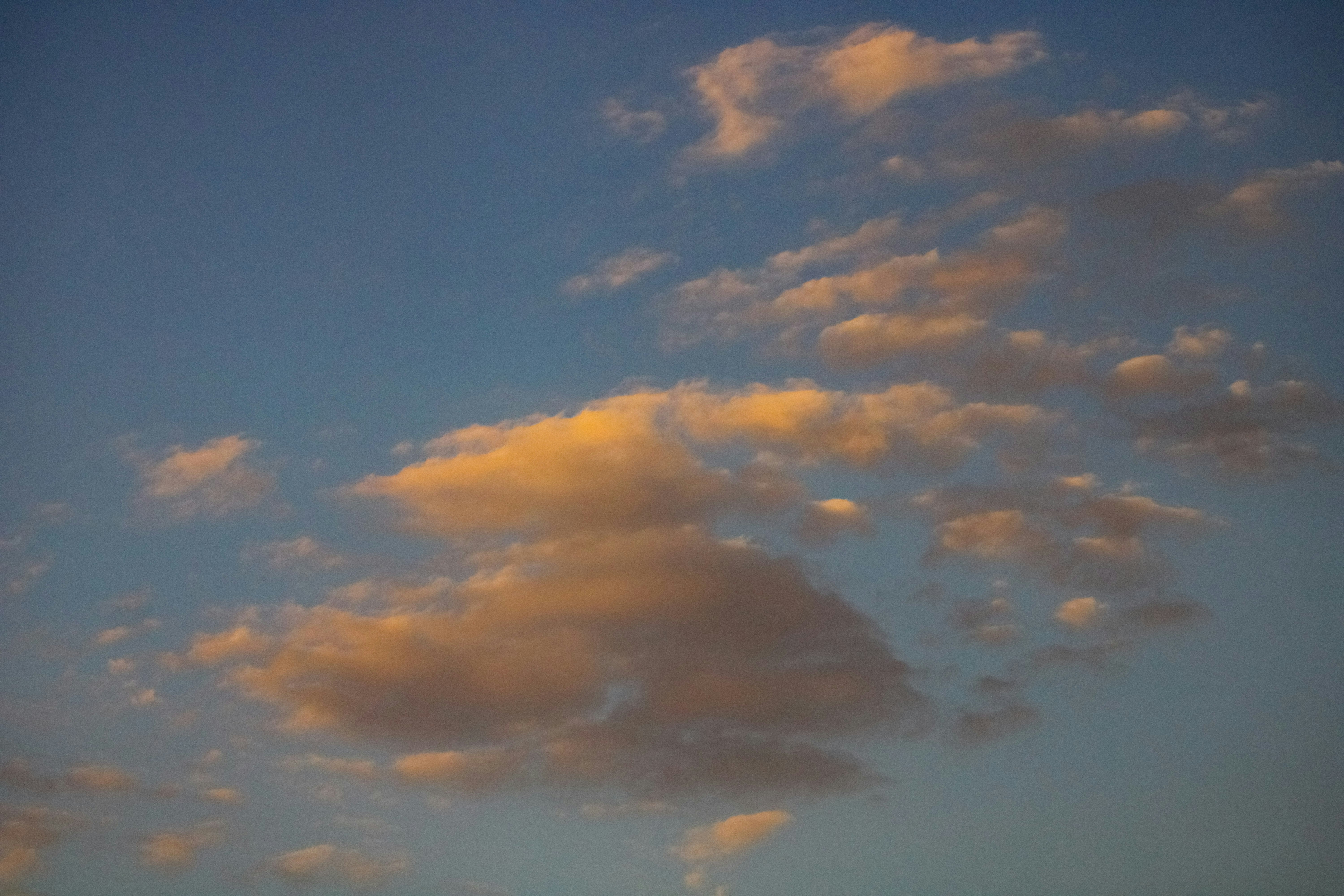 Golden Cloudlet Drift Across Quiet Evening Sky