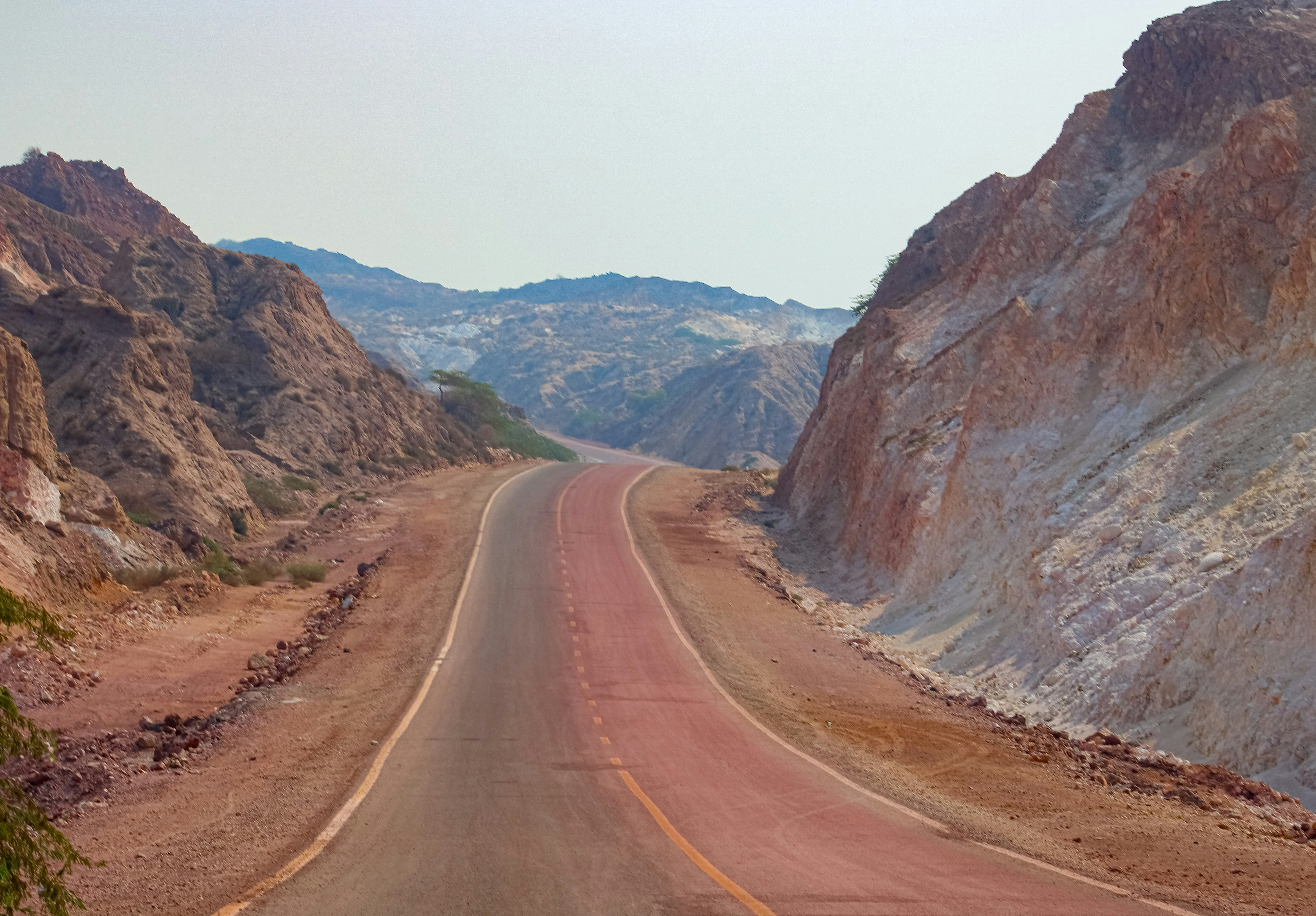 Desert Corridor: A Red-Painted Road Through Canyon Walls