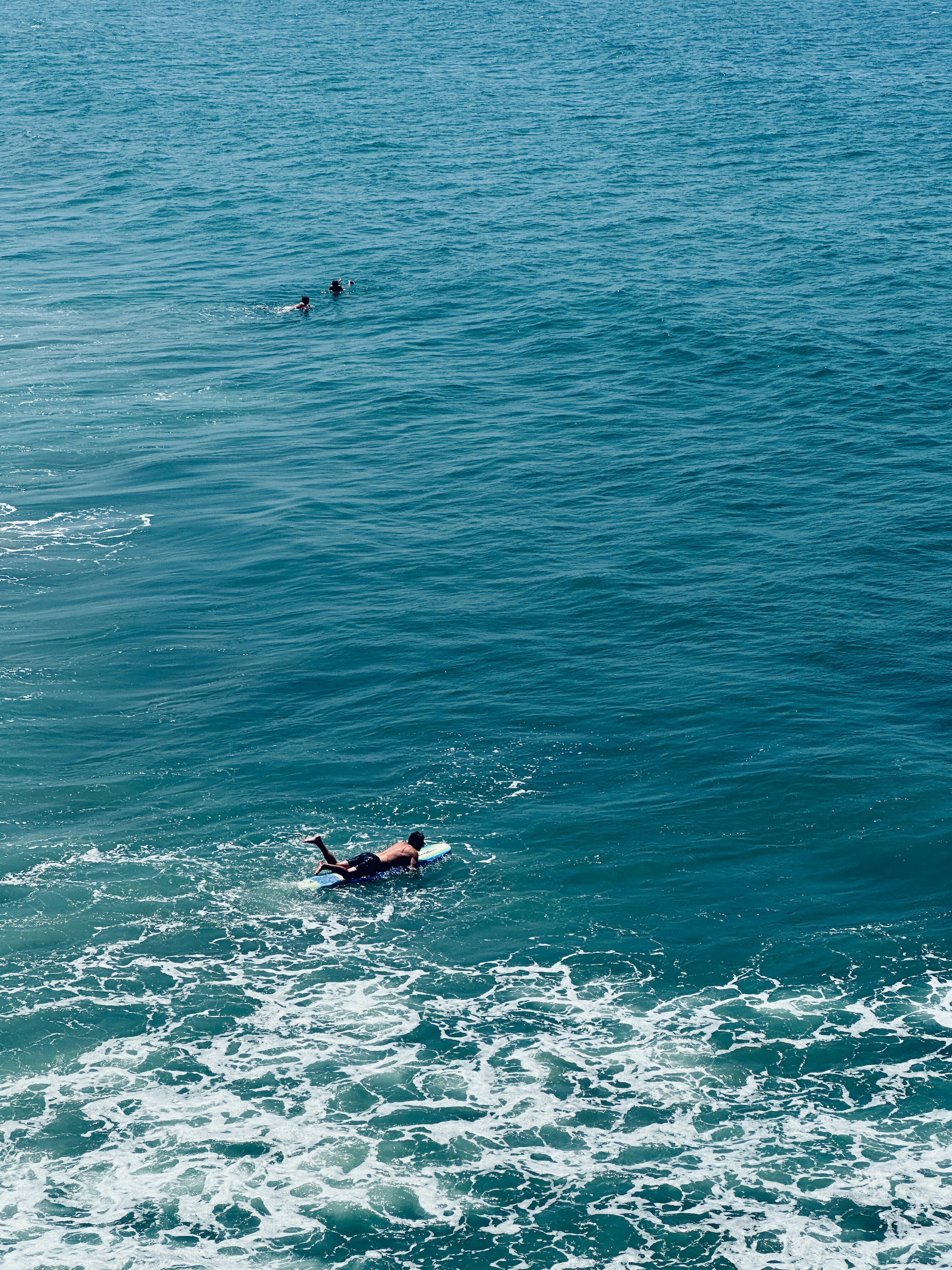 Solitary Surfer at the Lapping Ocean