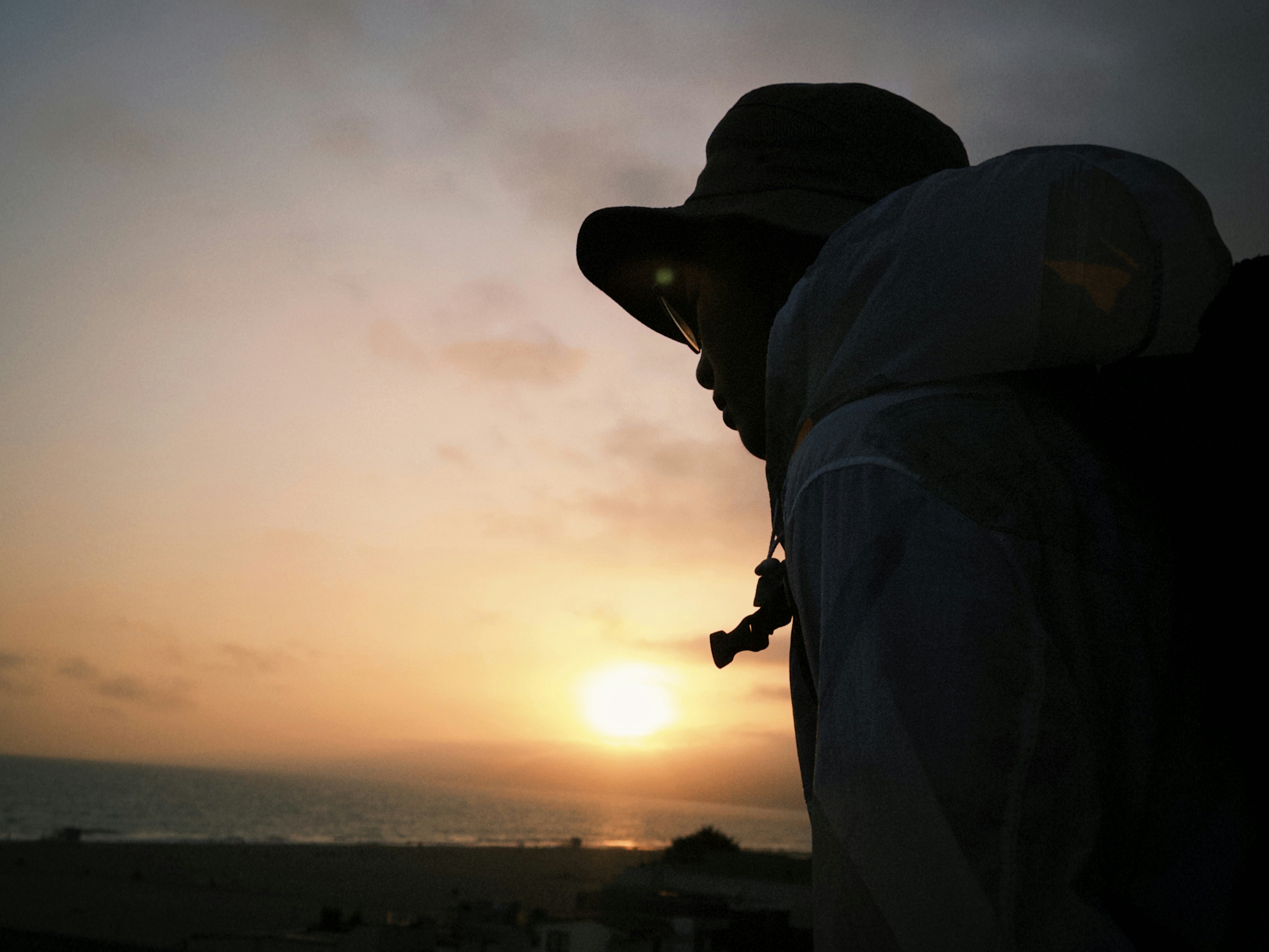 Silhouette at Sunset: A Quiet Portrait Against the Horizon