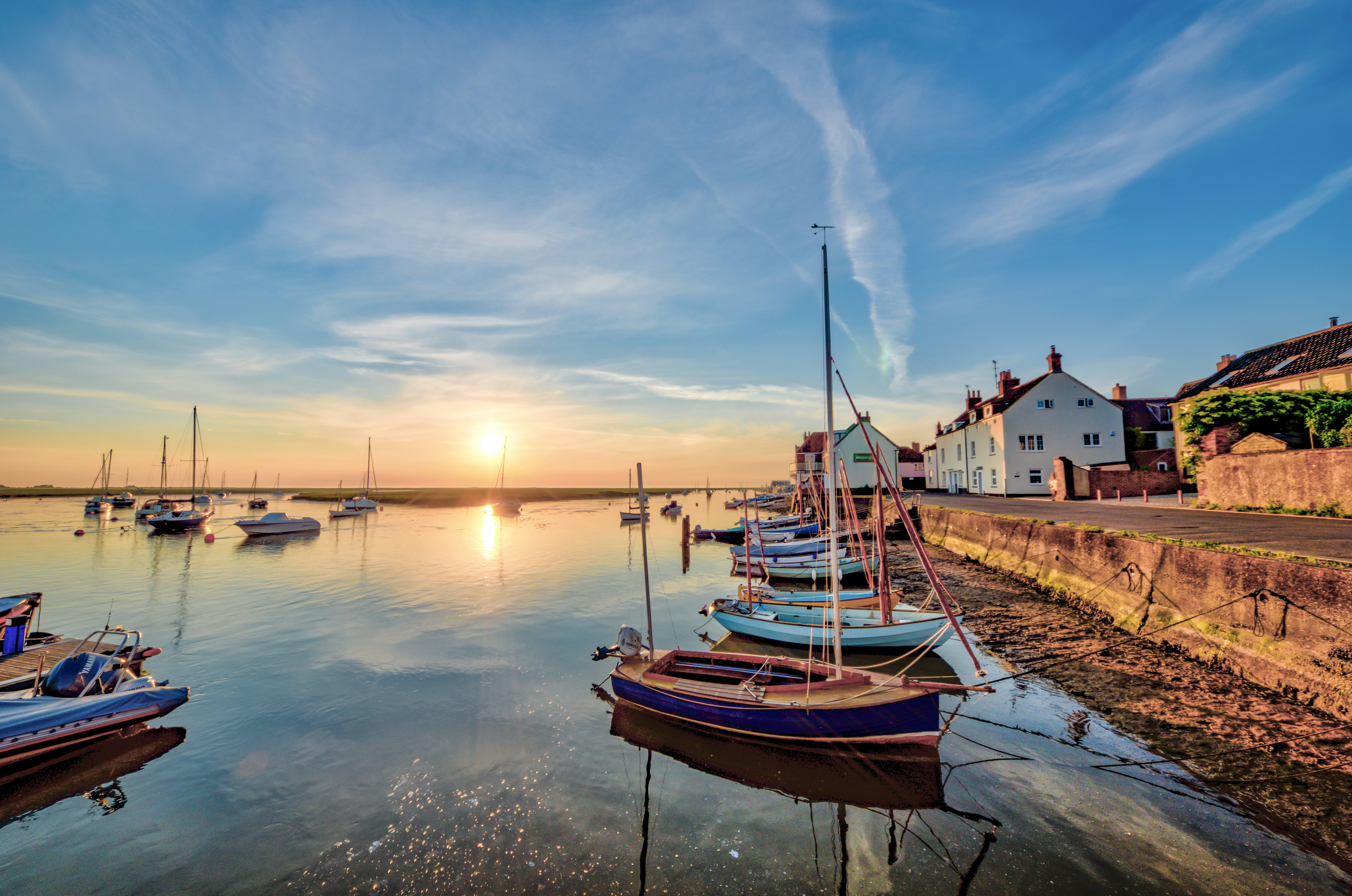 Sunlit Harbor: Boats Rest on a Quiet Tide as Dusk Approaches