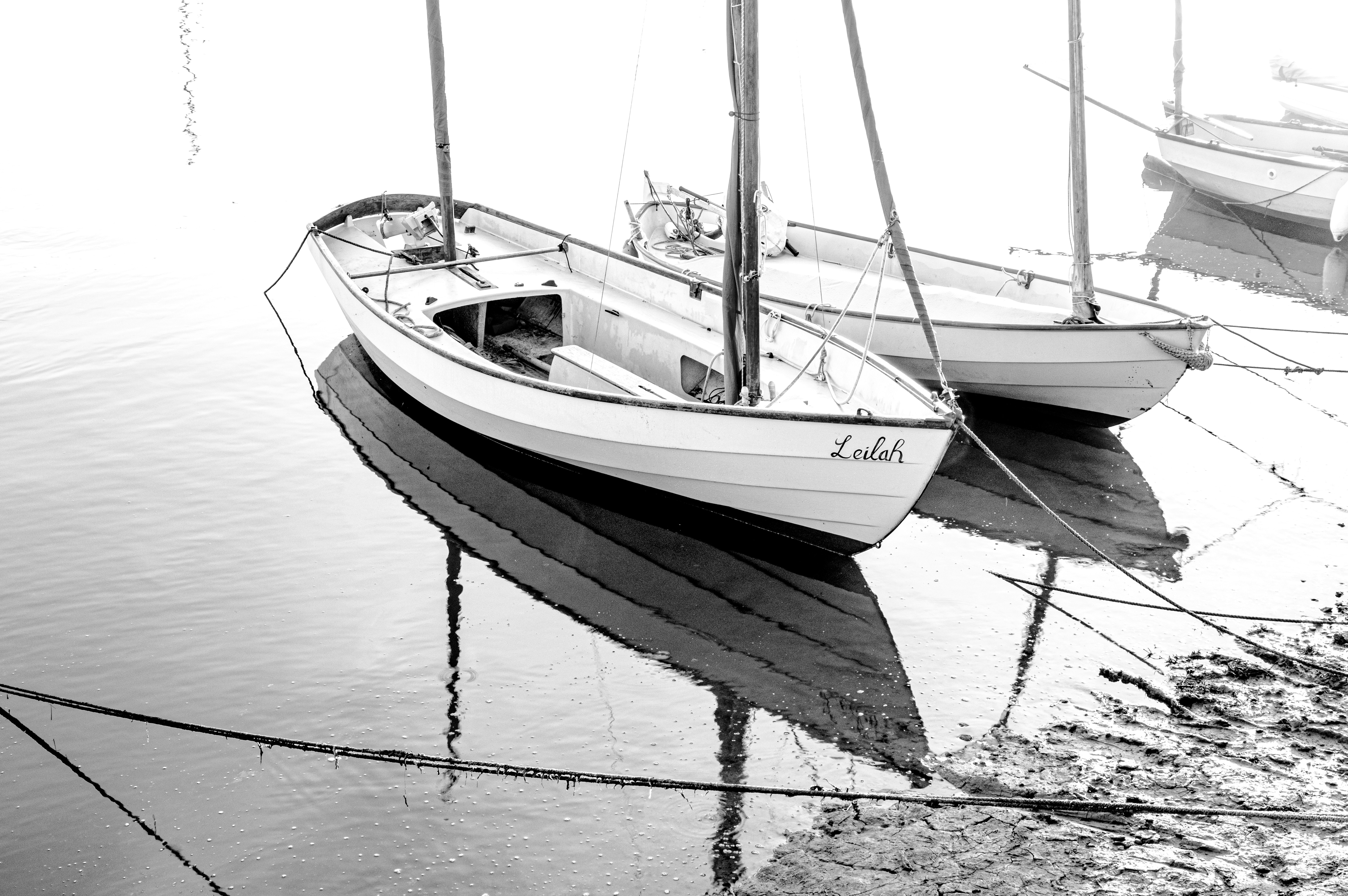 A Quiet Dock: Two Sloops Rest at the Calm Water's Edge