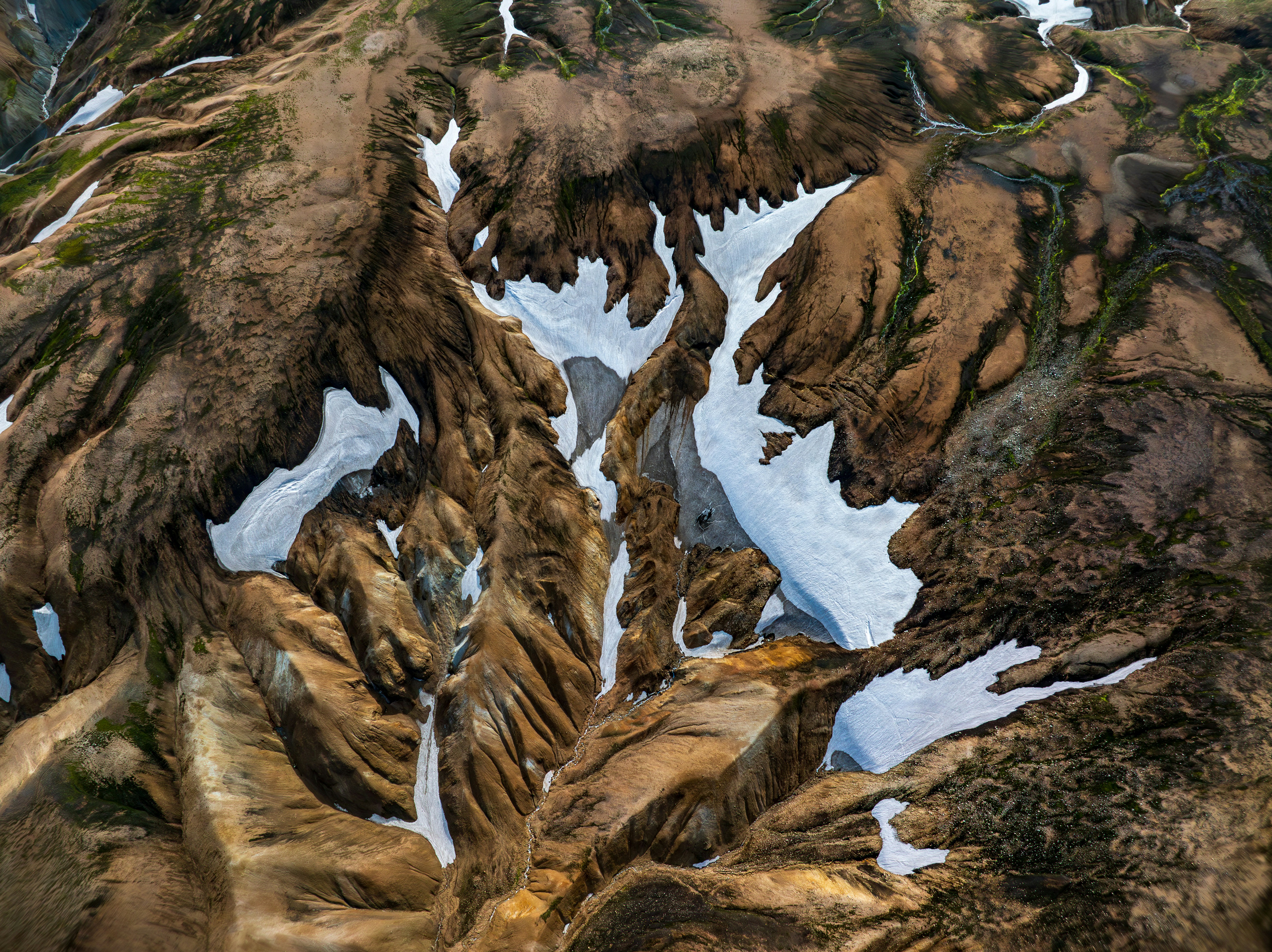 Warmed Canyon Carvings: Golden Rocks Embracing Snow Veins