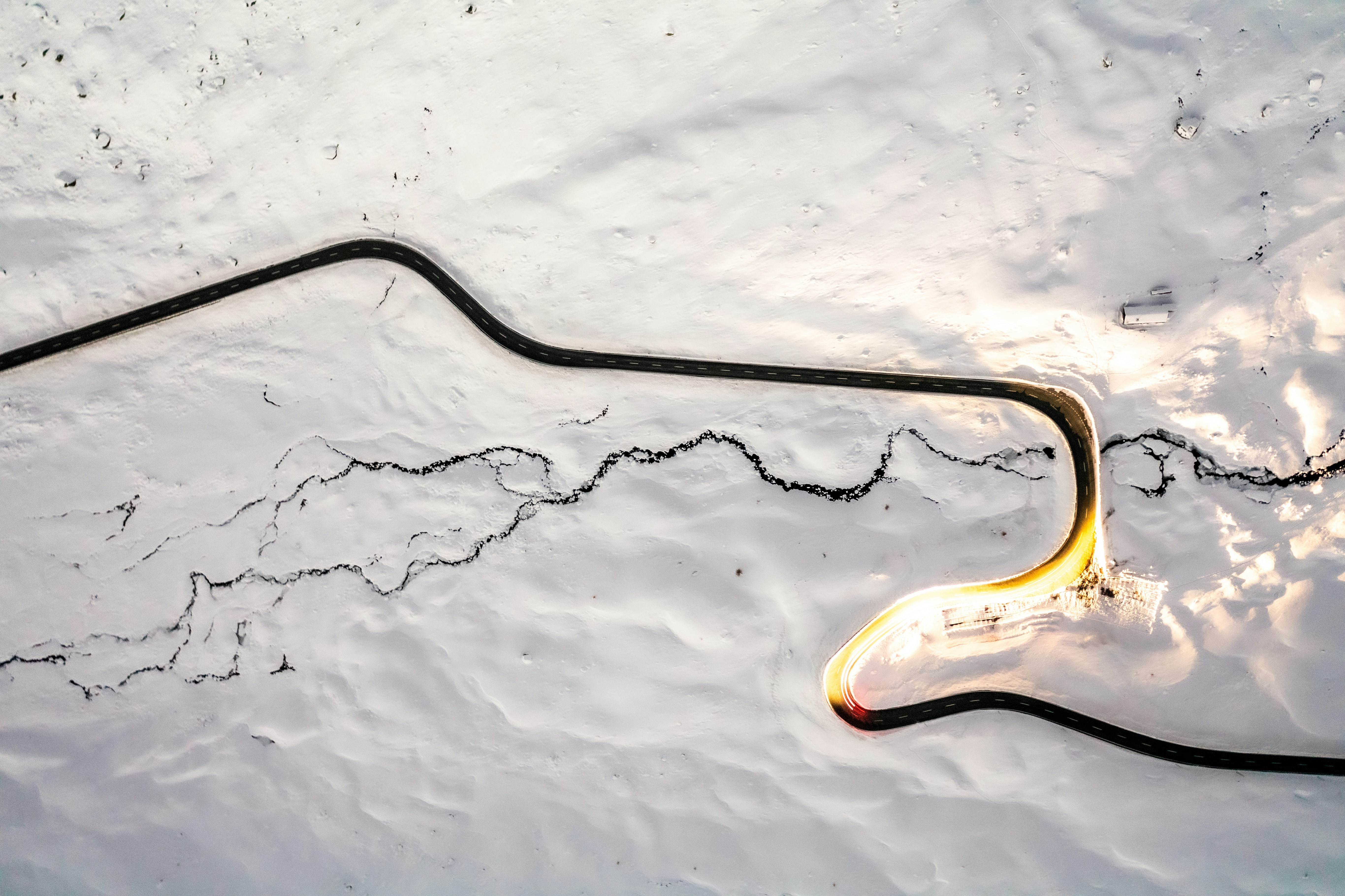 Curved Neon Pipeline Tracing Snow: A Quiet Study in Lines