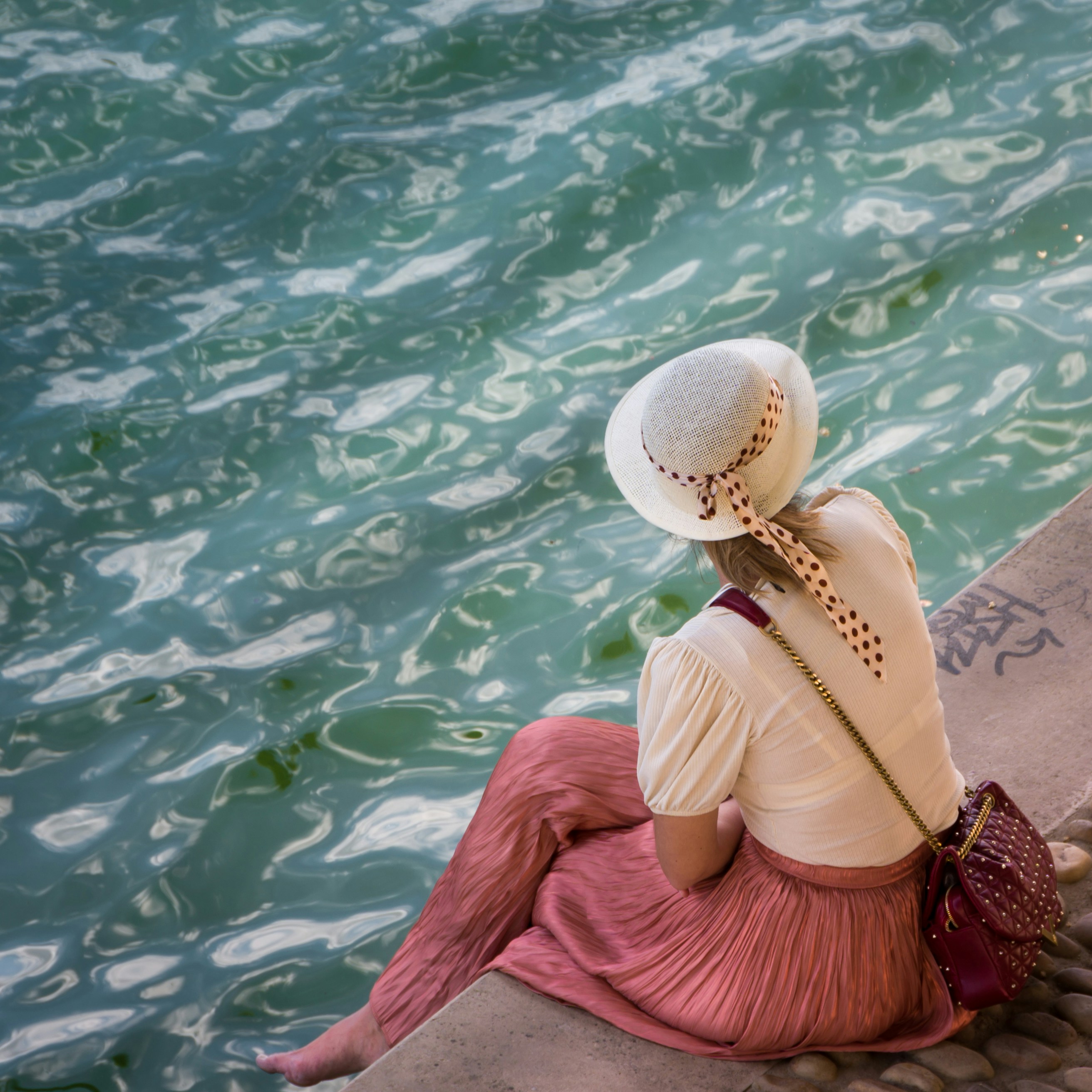 Seated by the Sea: A Sunlit Moment on the Pier