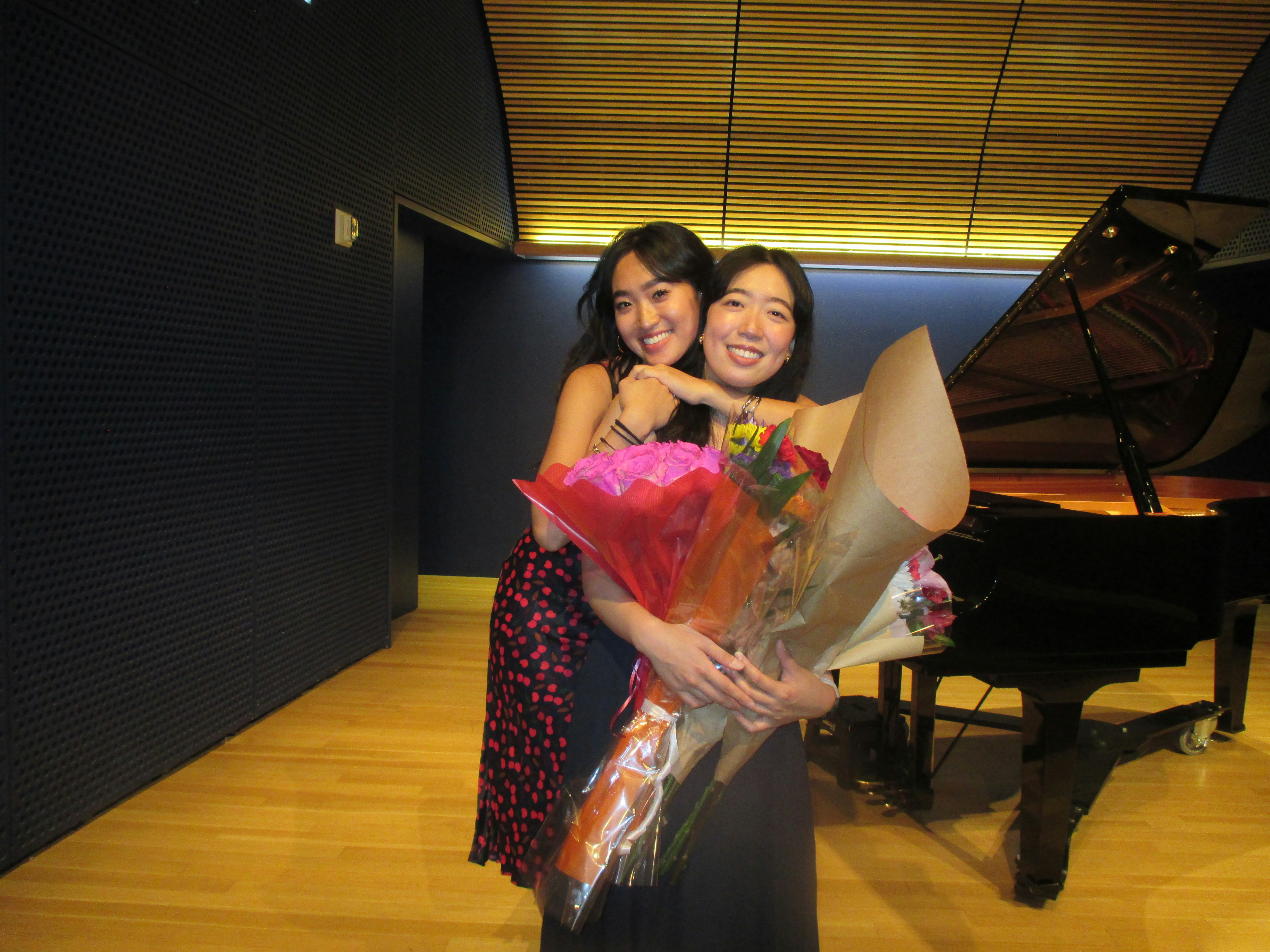 Bouquet and Bond: Duo Celebrates with a Piano Backdrop