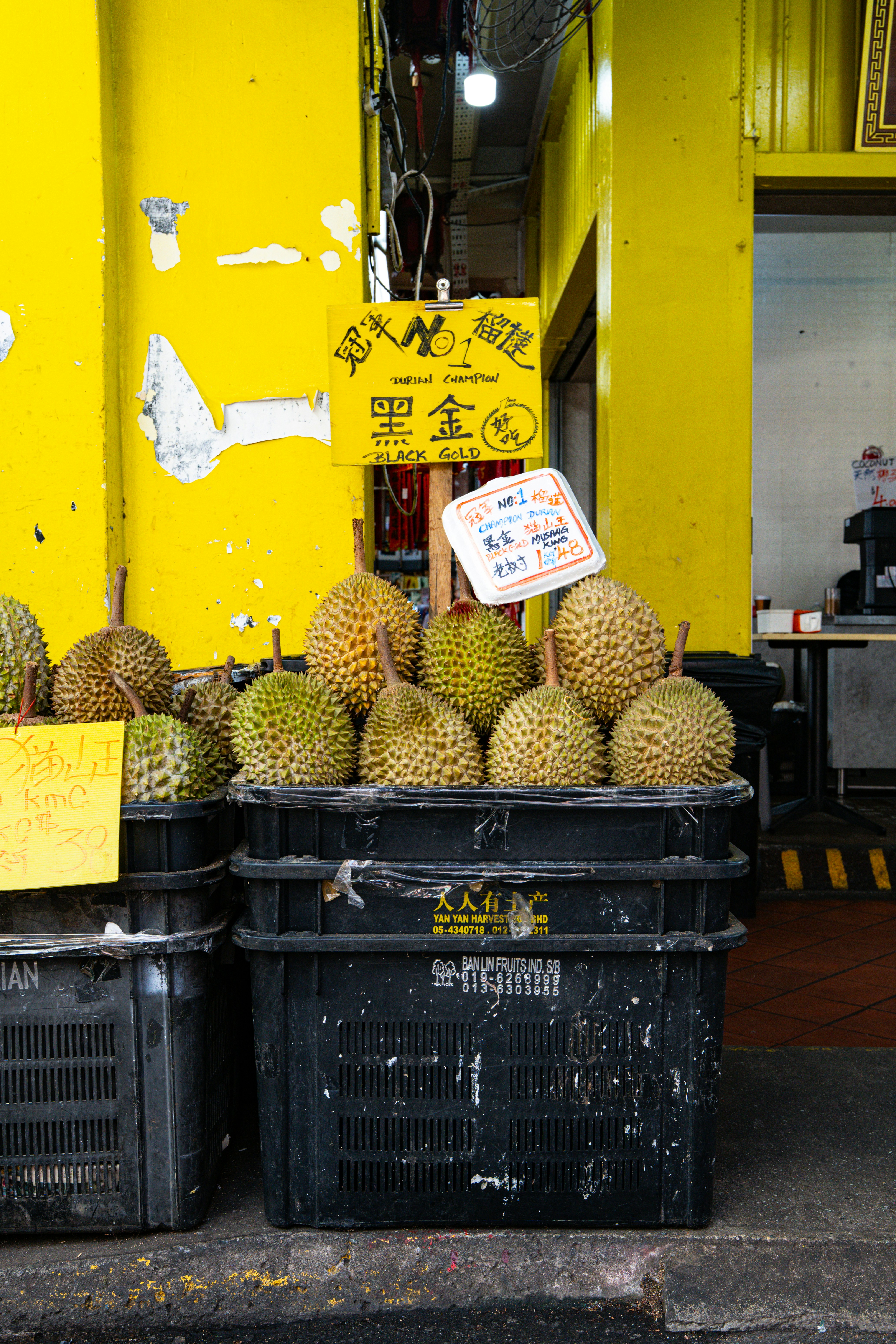 Golden Street Harvest: Durian Stacks Against Neon Yellow