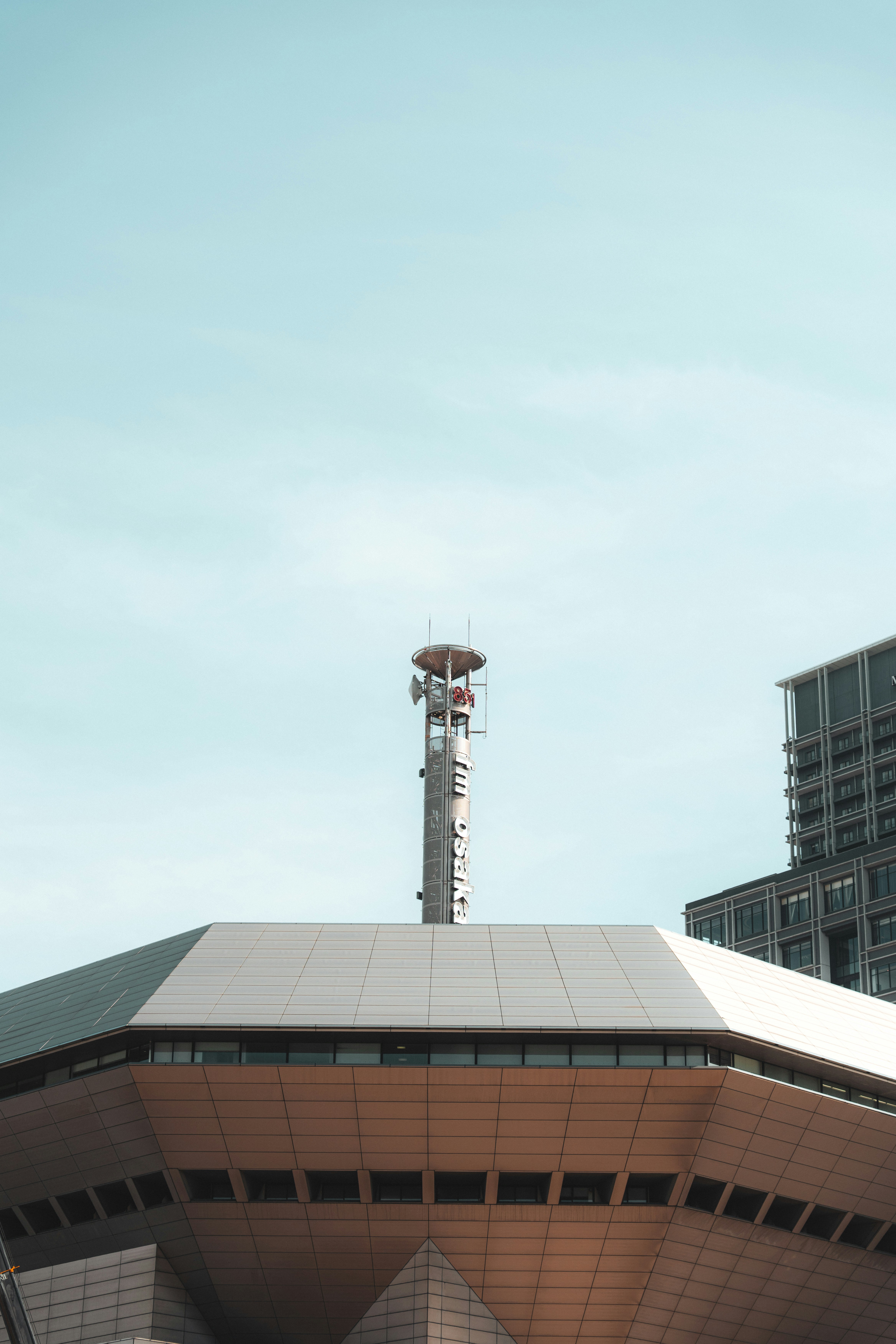 Skyline Spotlight: The Tower Silhouette Above a Modern Roof