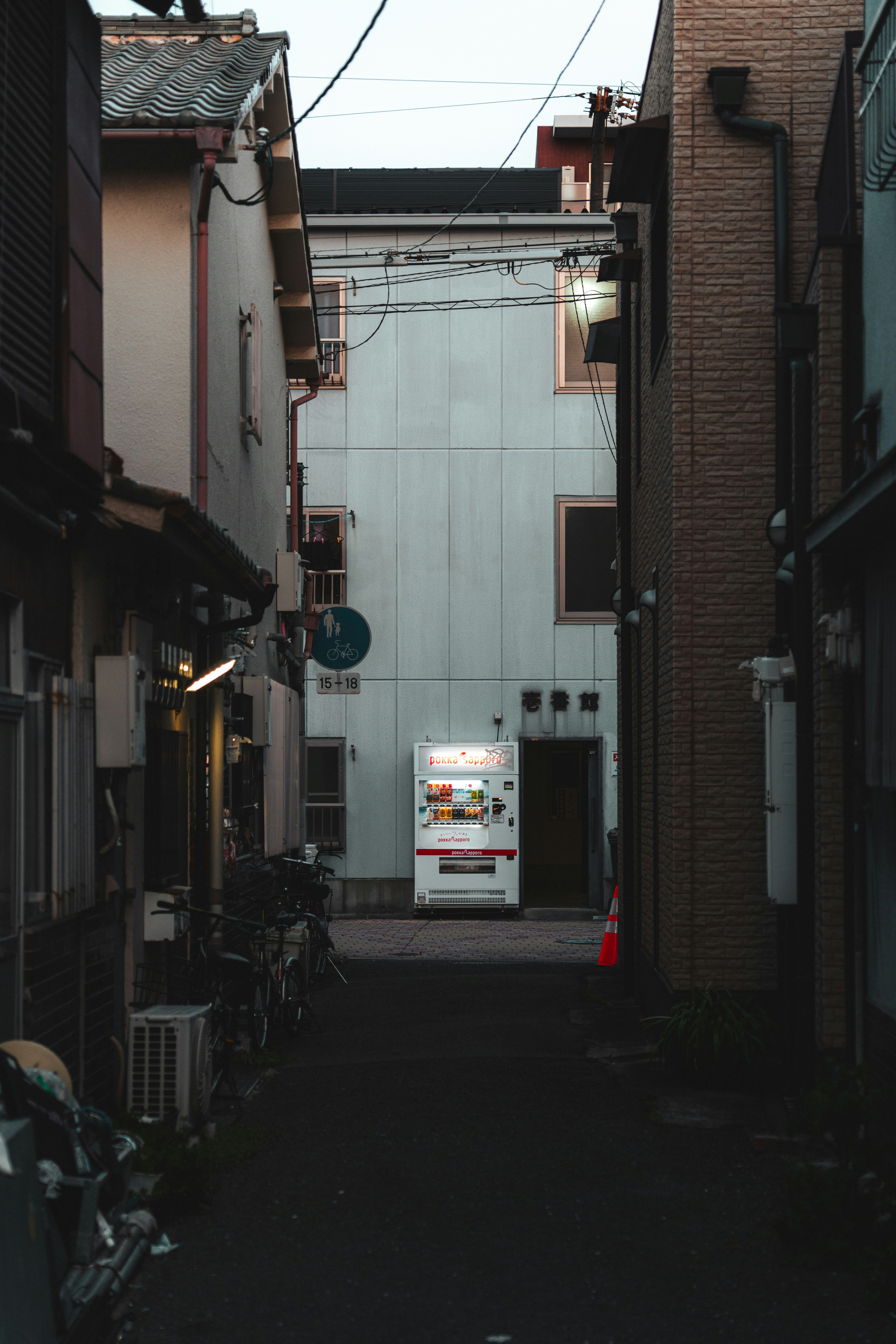 Quiet Vantage: a vending machine at the end of a narrow alley