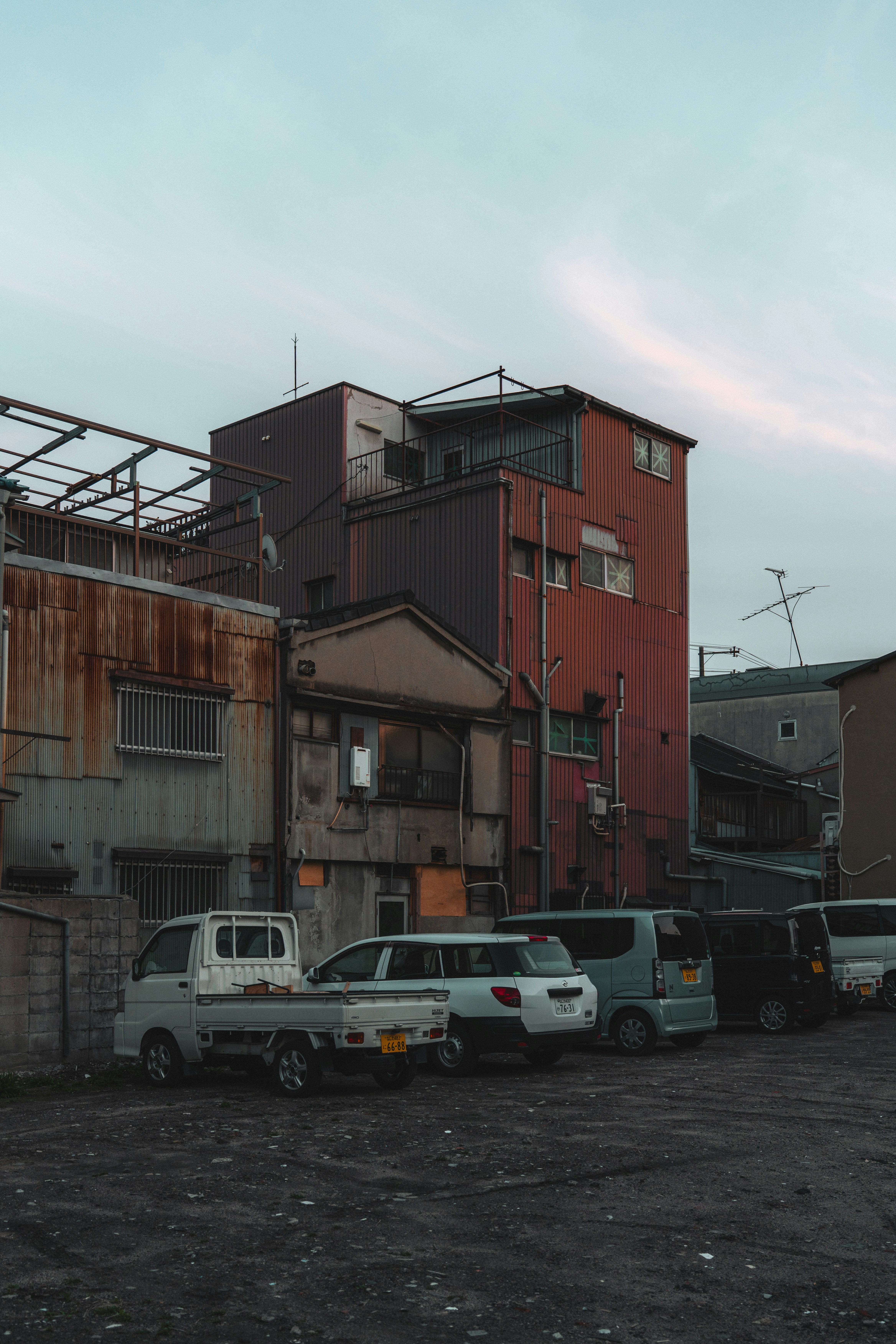 Weathered Red: A Quiet Riverside of Rust and Runway-Quiet Cars