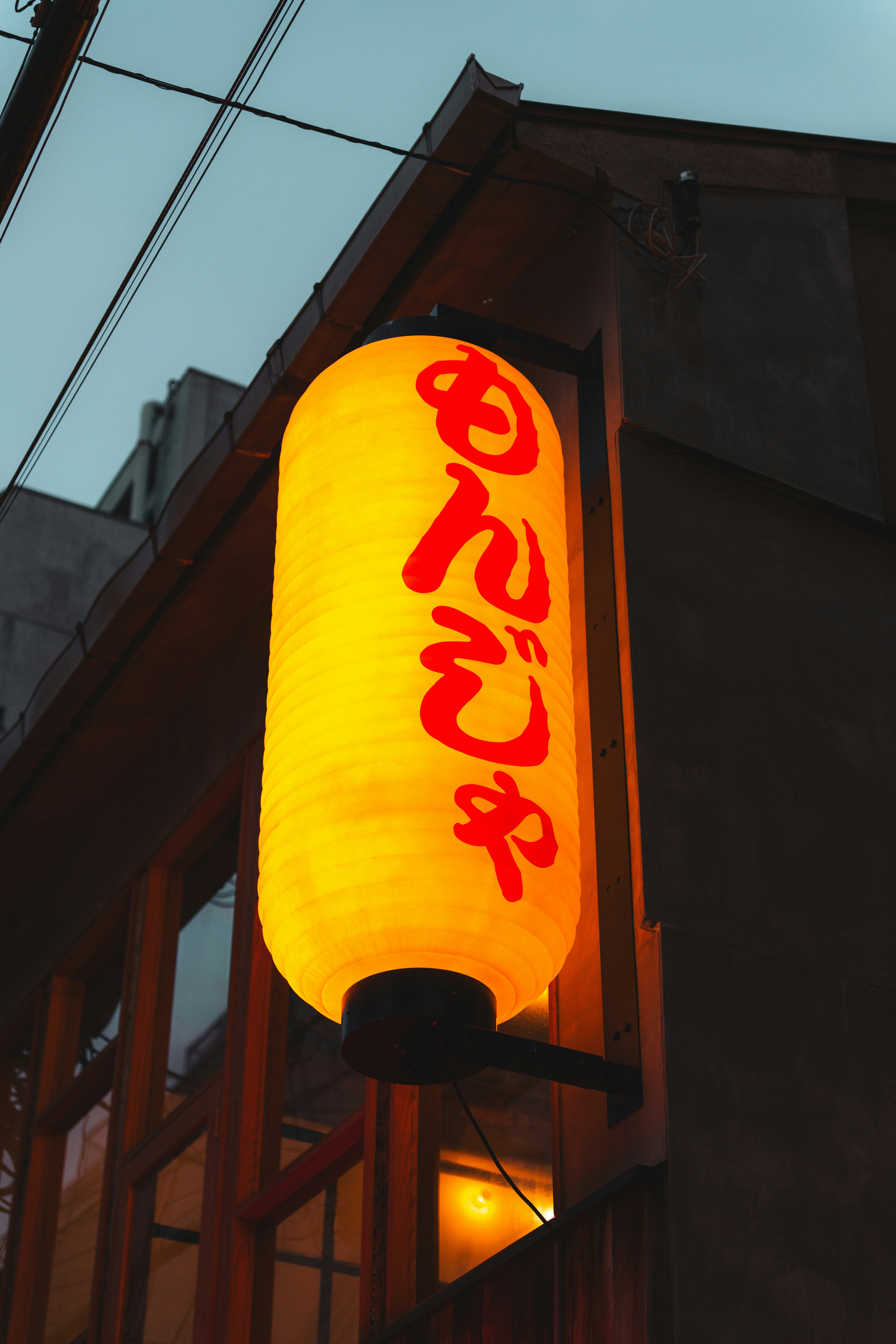 Illuminated Lantern on a Quiet Urban Wall