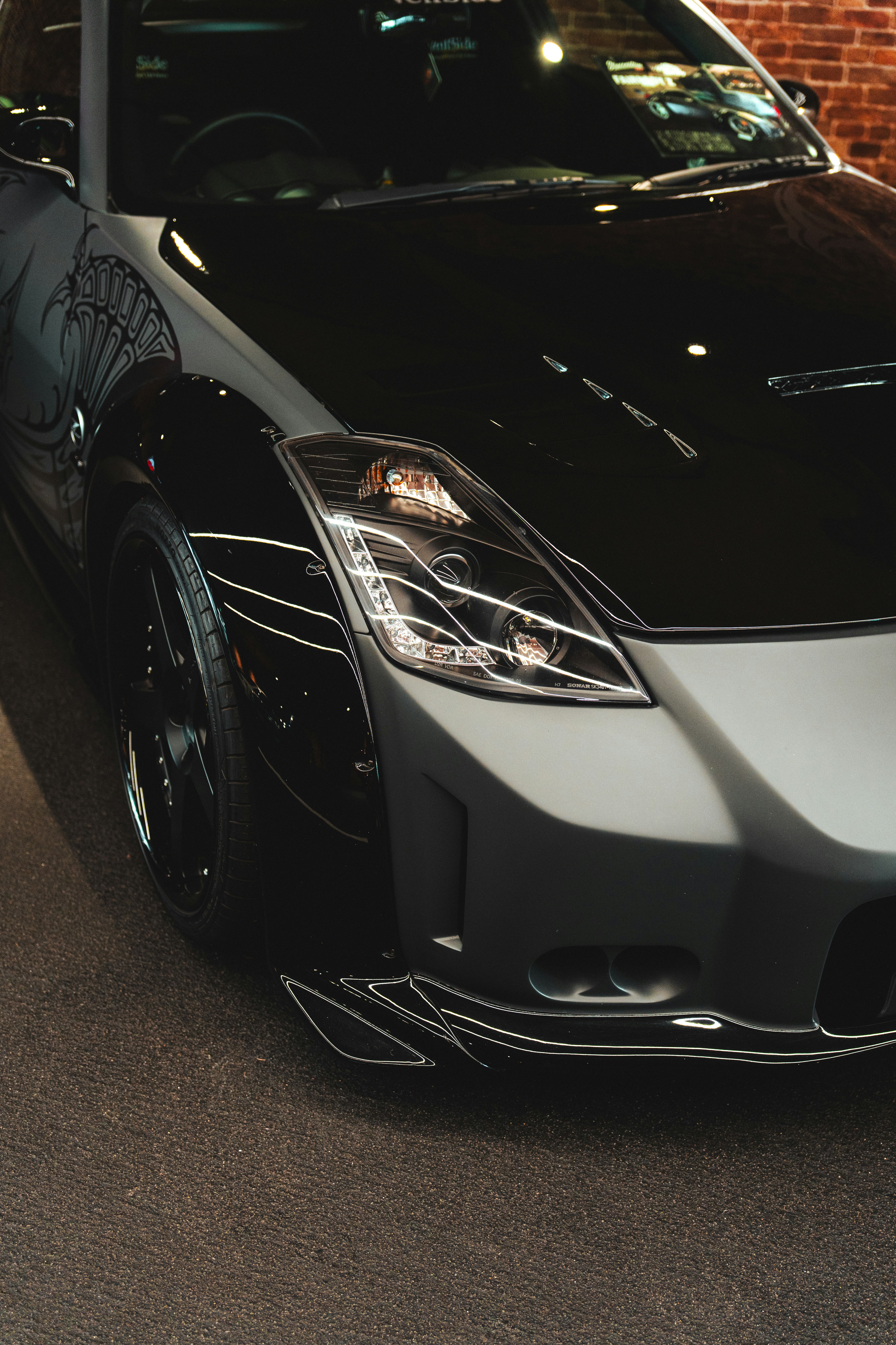 Low-Angle Close-Up of the Front End of a Matte-Black Sports Car