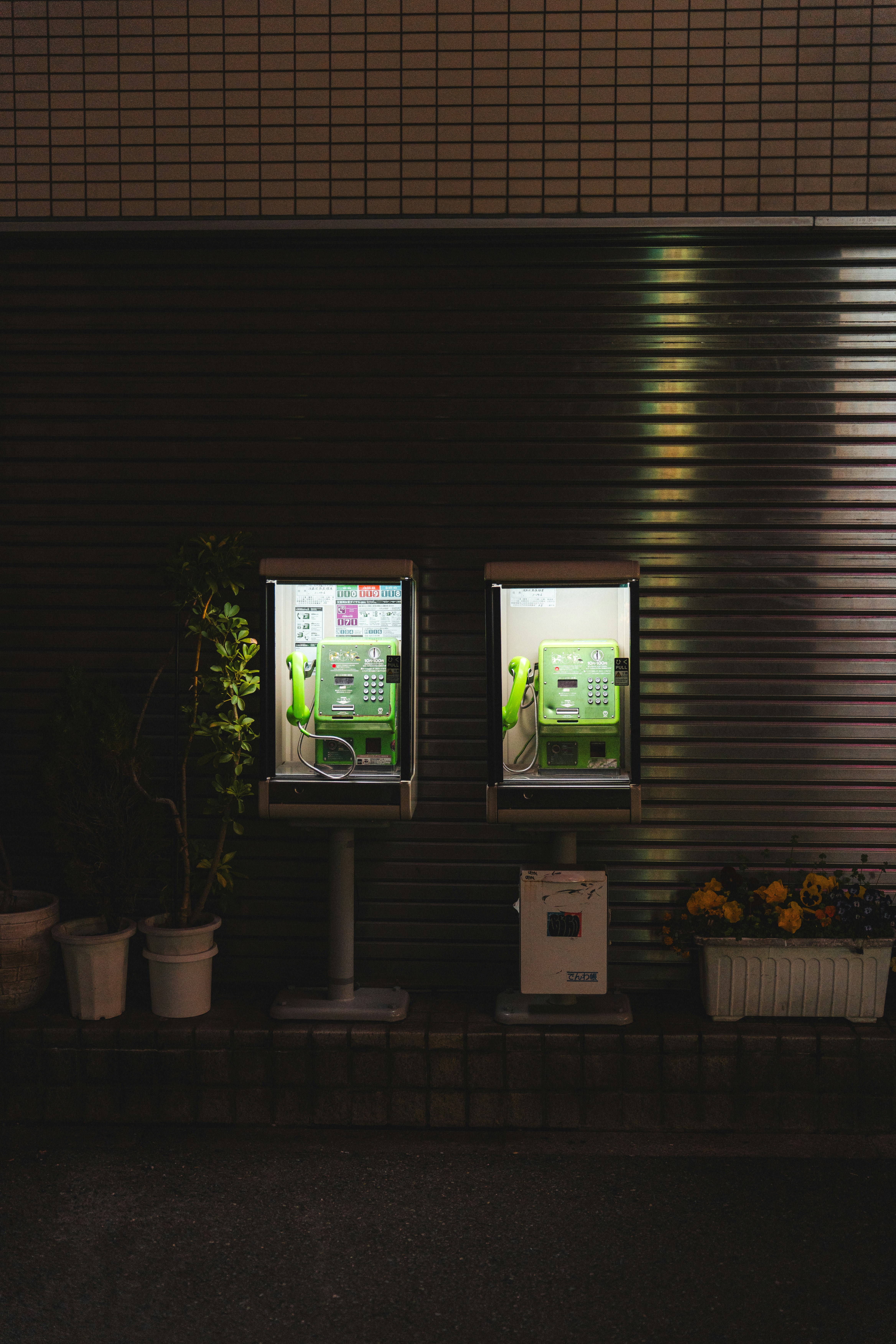 Green Payphones Under Night Lights