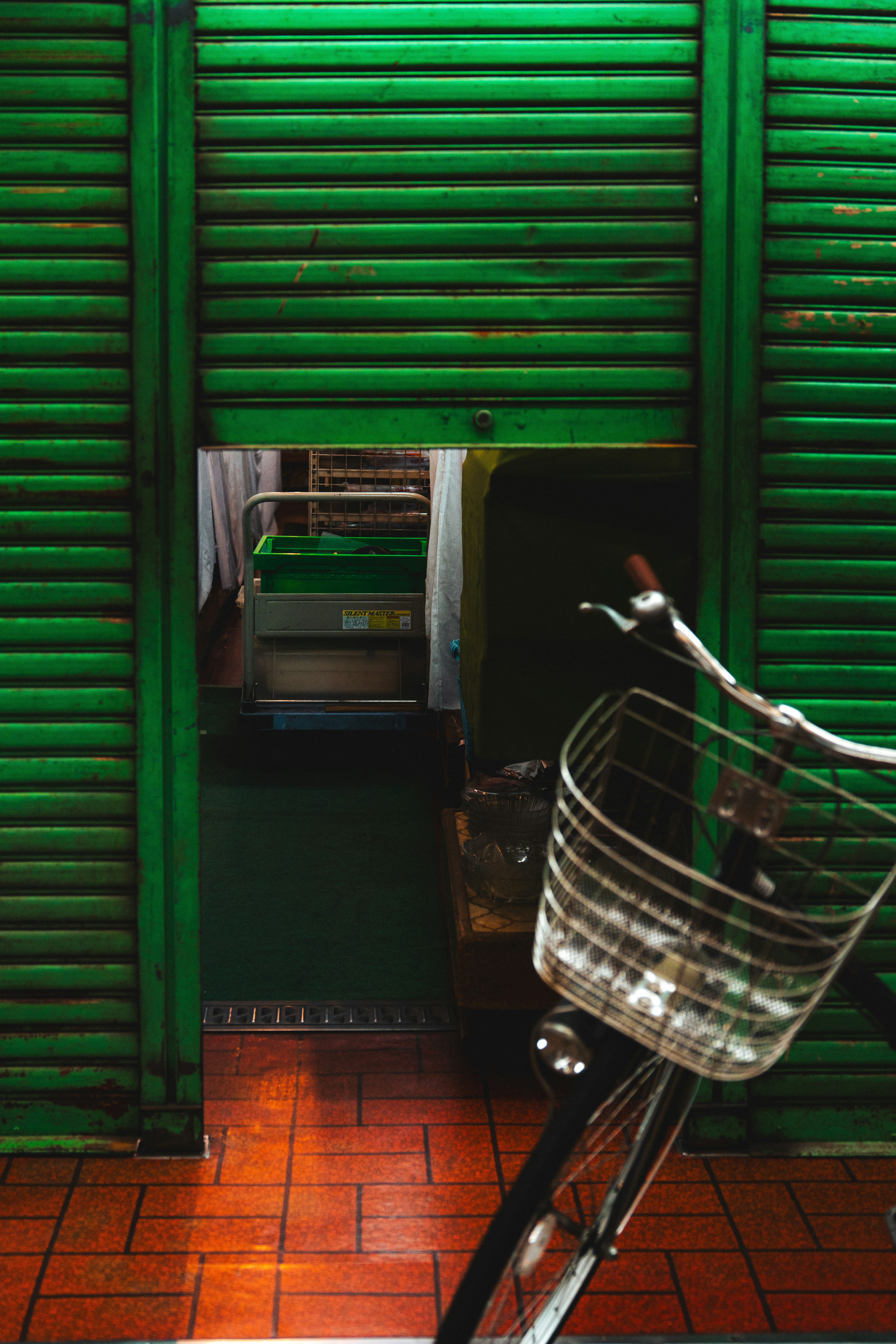 Green Alleyway Exit: A Bicycle Frame Aligns with Industrial Neons