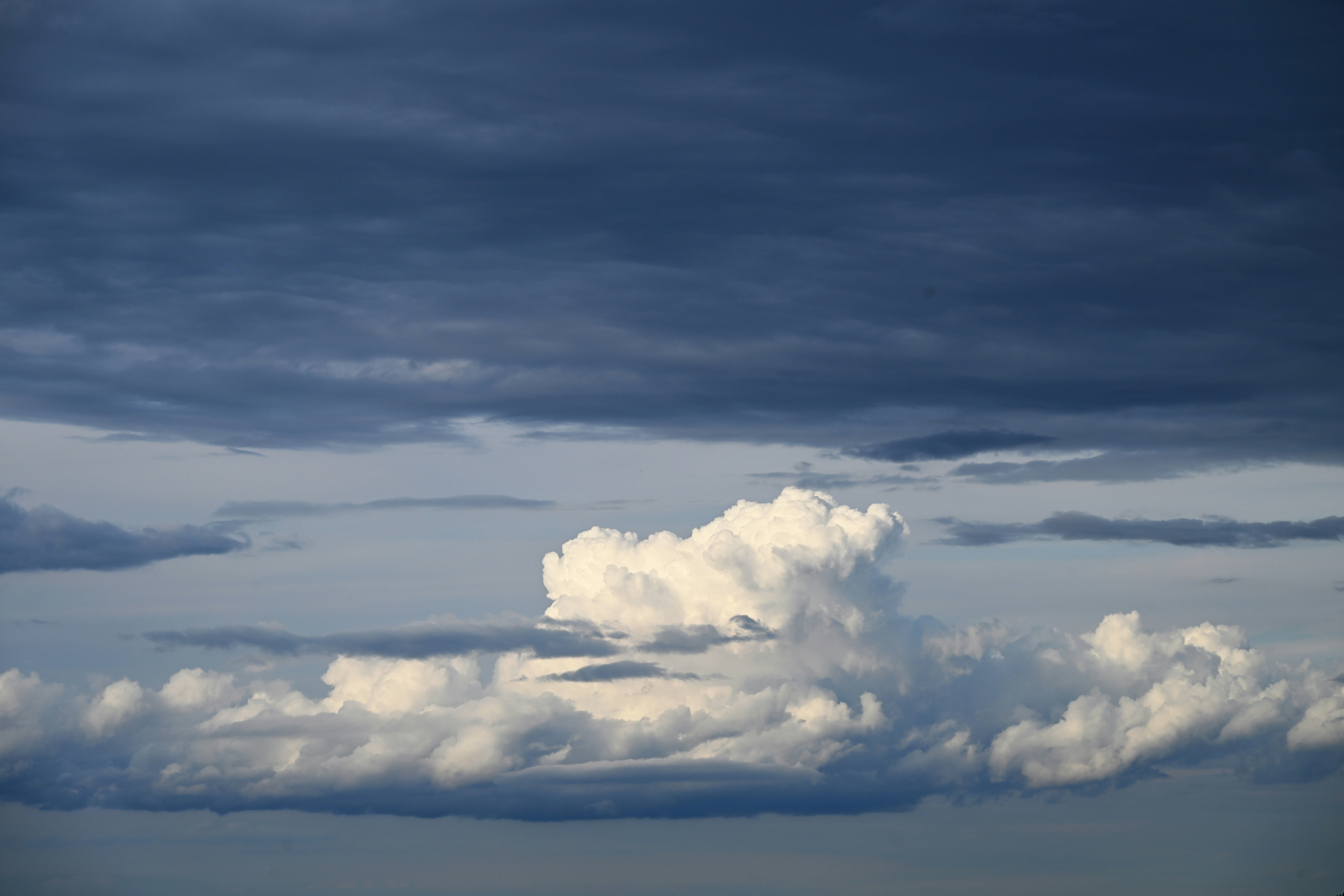 Cloudscape at Midday: A Layered Sky Over a Quiet Horizon