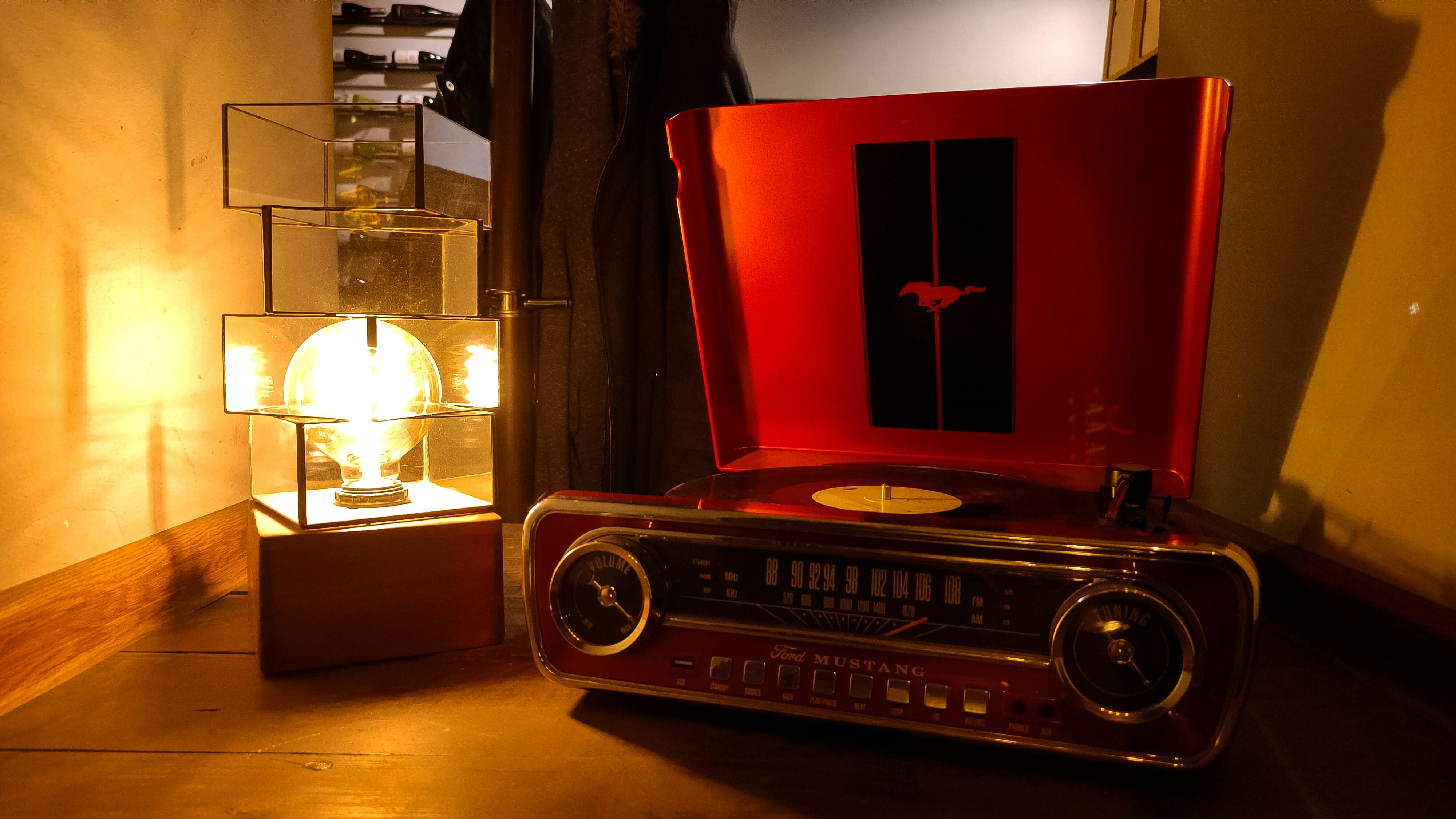 Retro Glow: A Red Console and Warm Lamp in a Quiet Corner