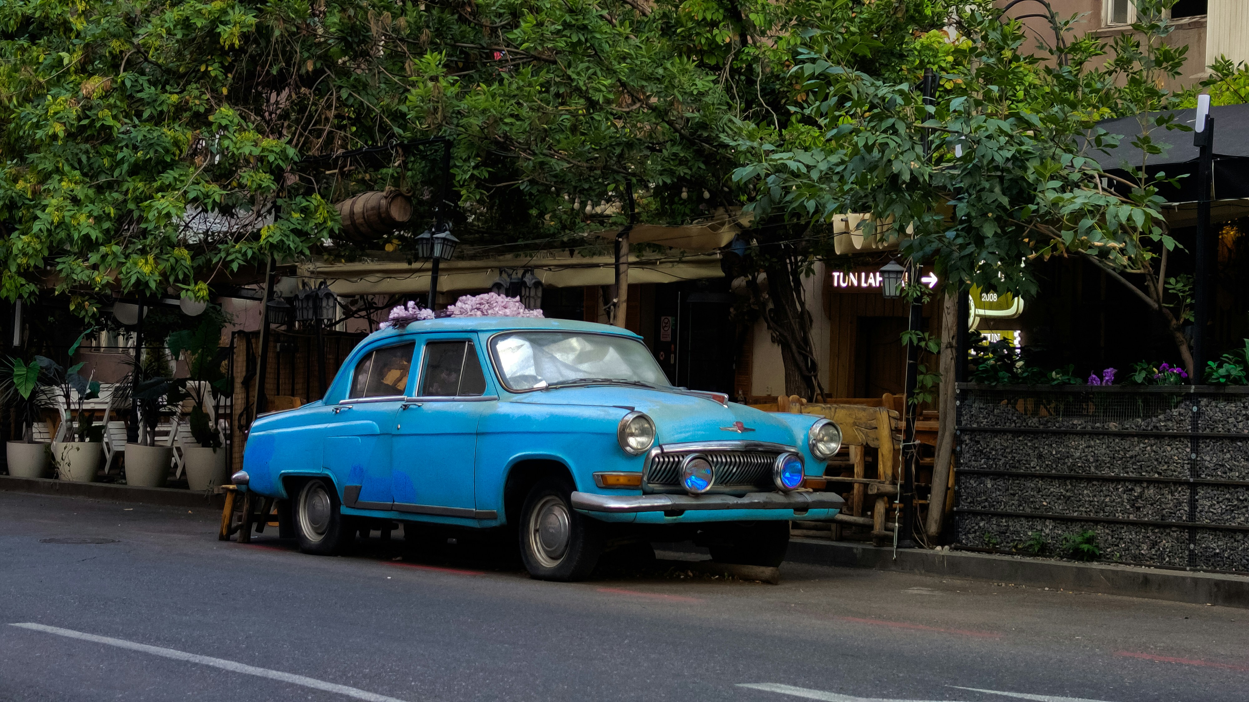 Pastel Blue Classic: A Retro Sedan Anchors a Quiet Street