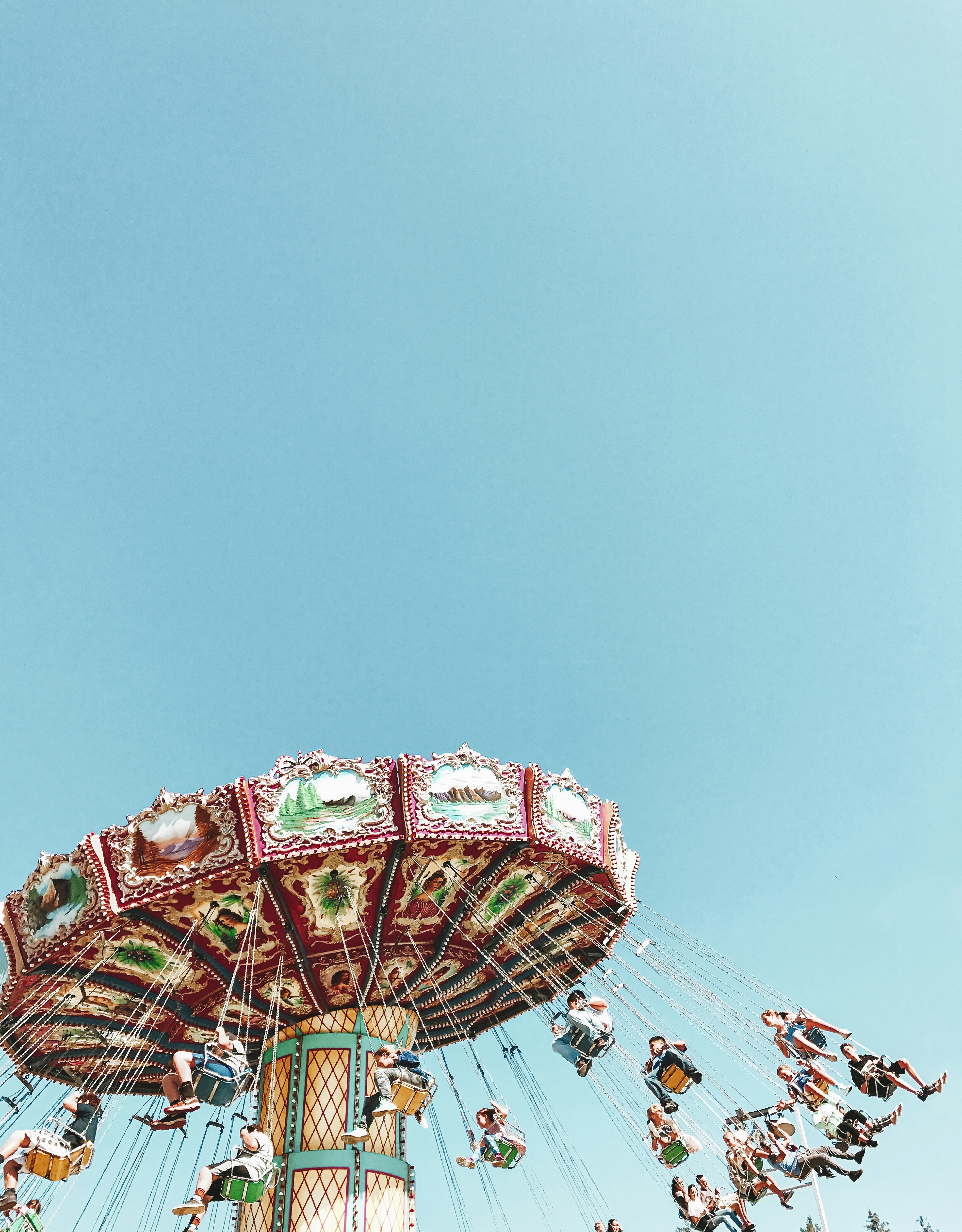 Swinging to the Sky: Carousel Ride Under a Clear Blue