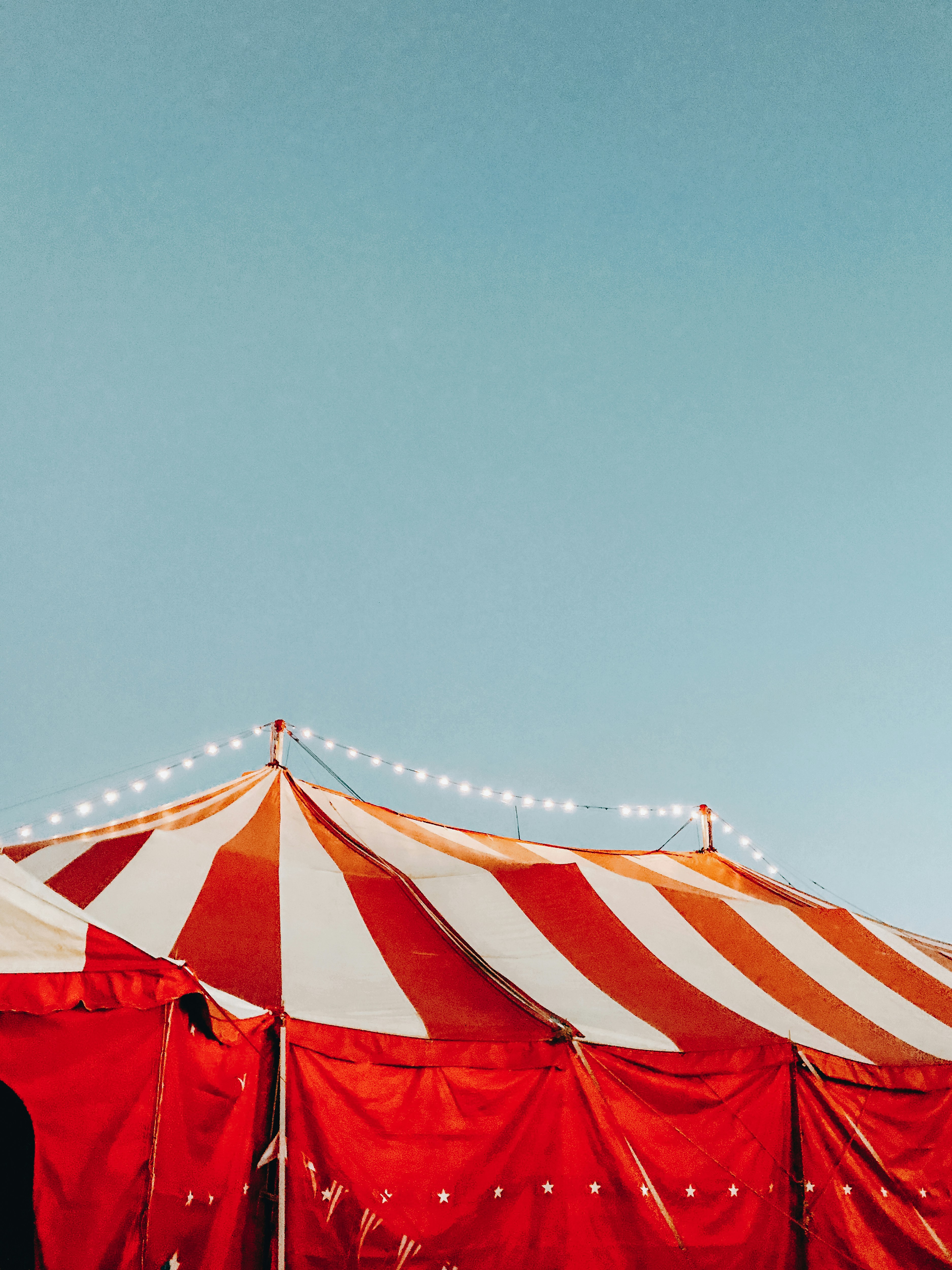Red-and-White Circus Canopy Under a Clear Evening Sky