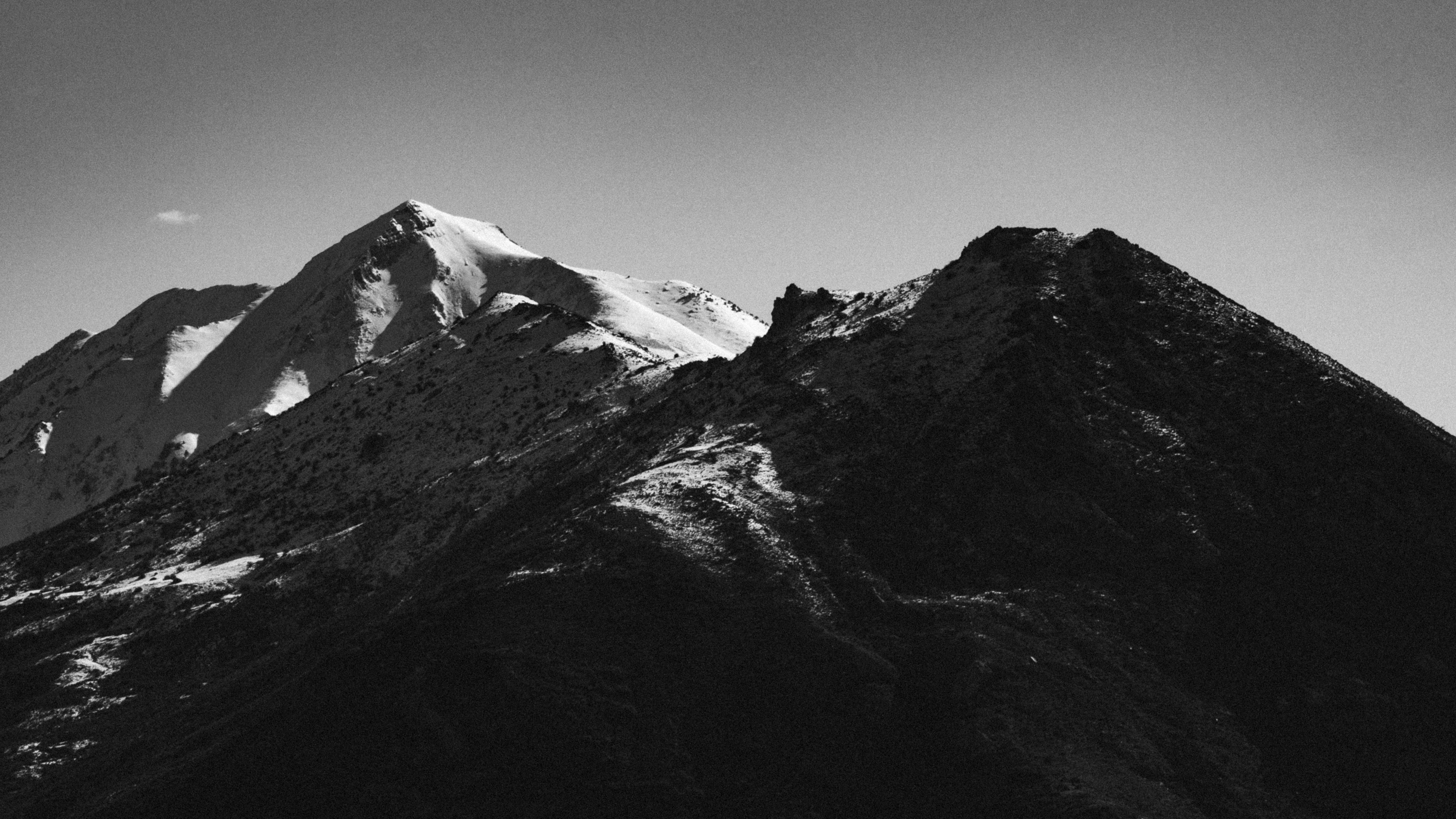 Snow-Capped Peak Rising from the Shadowed Ridge