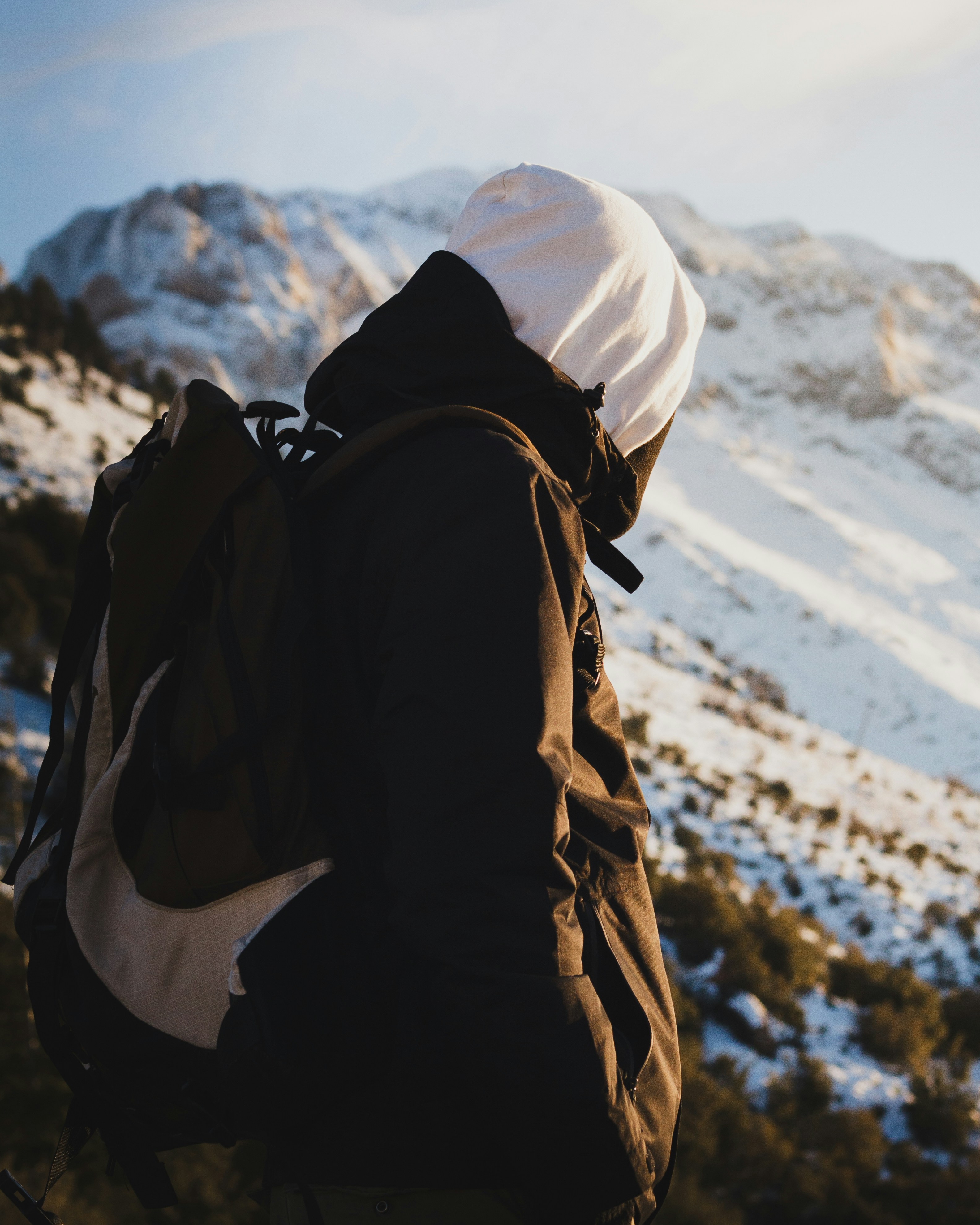 Snowbound Explorer: The Backpack Pioneer Beneath Alpine Light