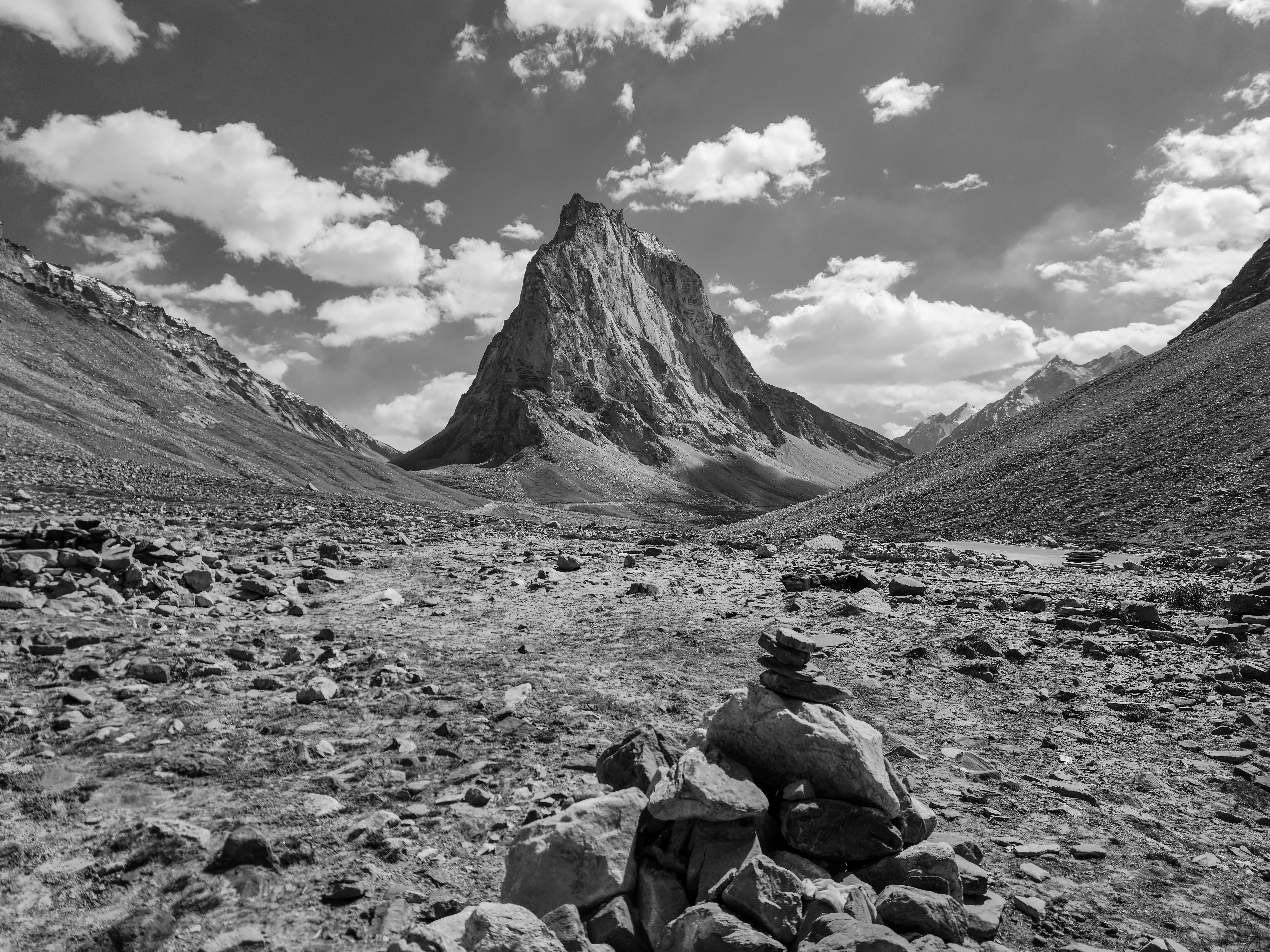 Peak Convergence: Stone Pyramid Trail Beneath a Skyward Peak