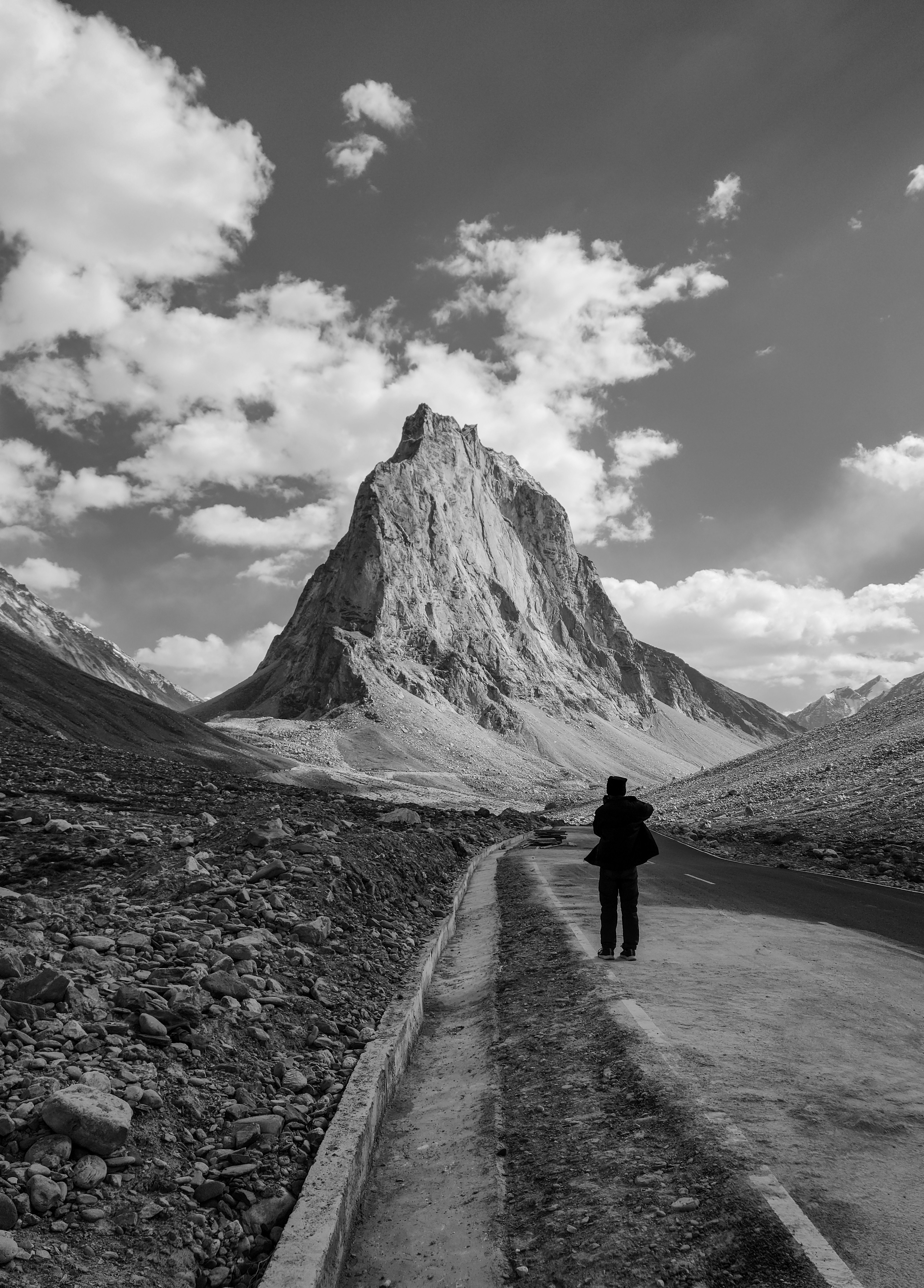 Solo Traveler Faces the Peak: A Monochrome Ascent