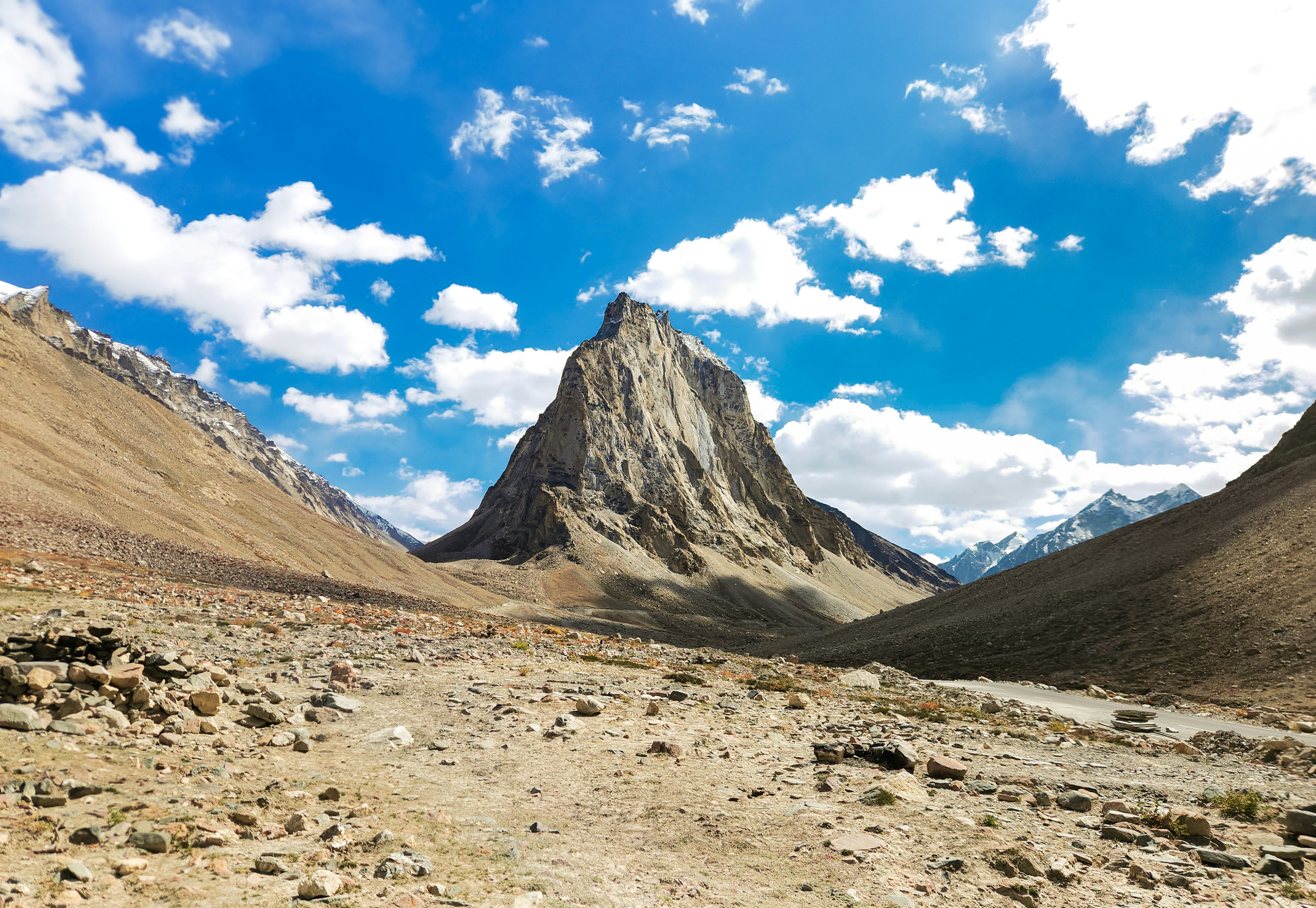 Central Peak Under a Vast Sky: A Deserted Valley Opens to a Sharp Summit