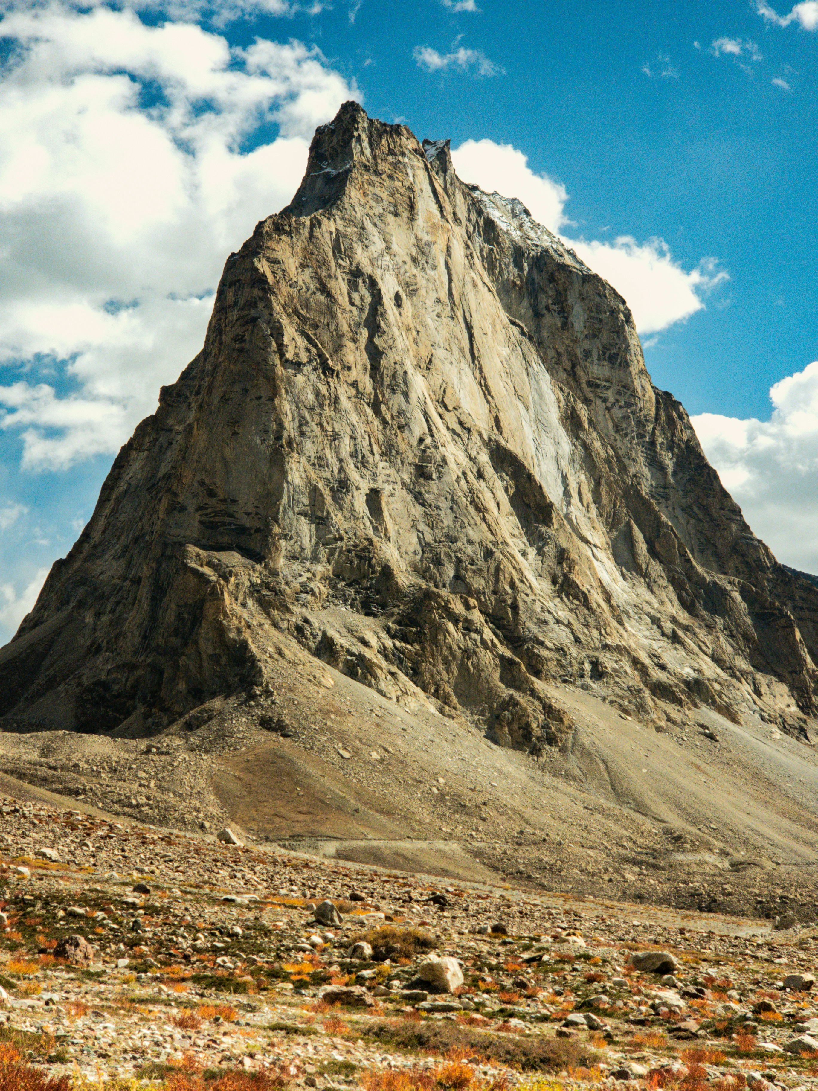 Peak’s Shadow: A Towering Monolith Rising from Desert Floor