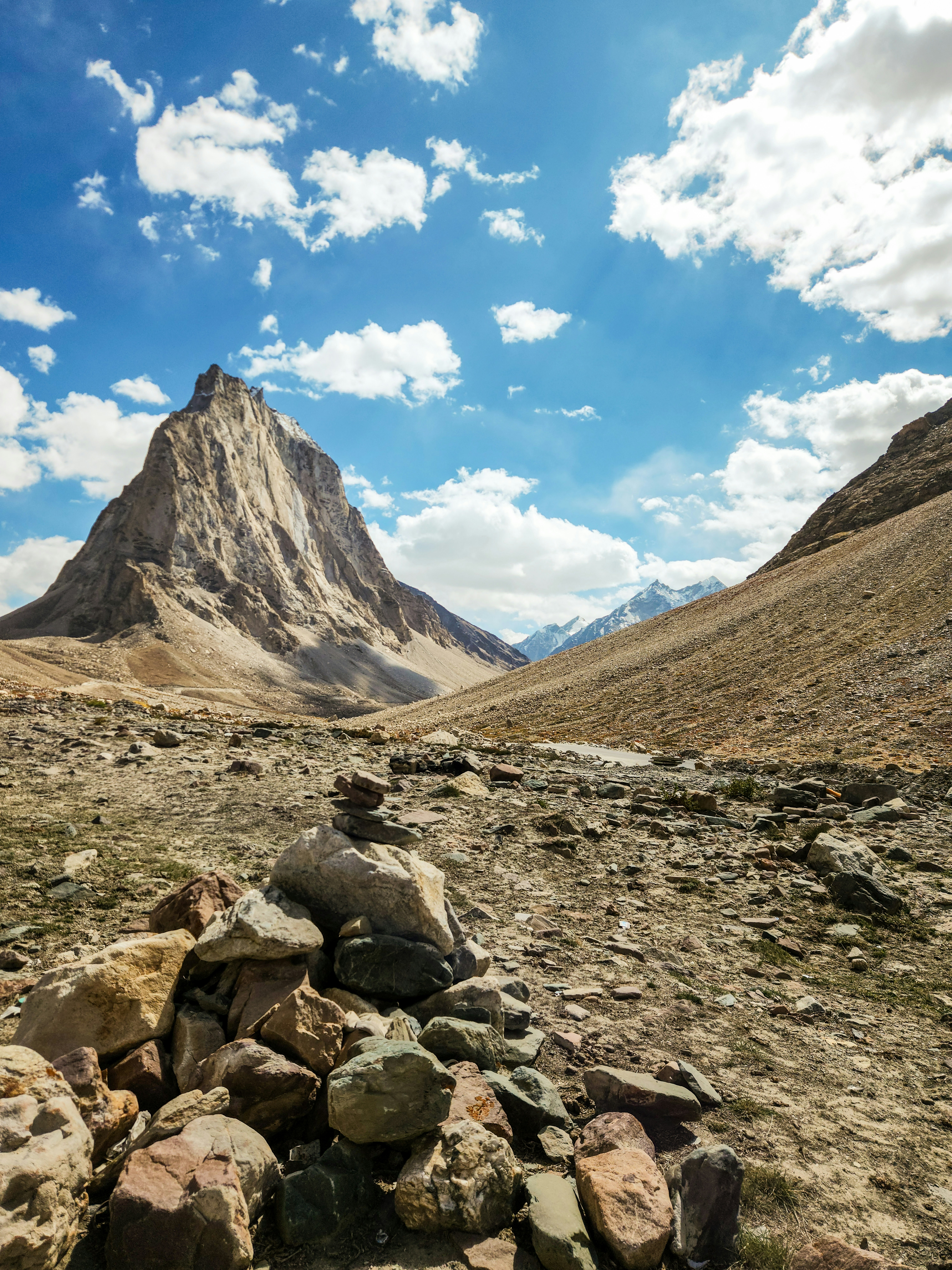 Stone Pyramid at the Base of Jagged Peaks