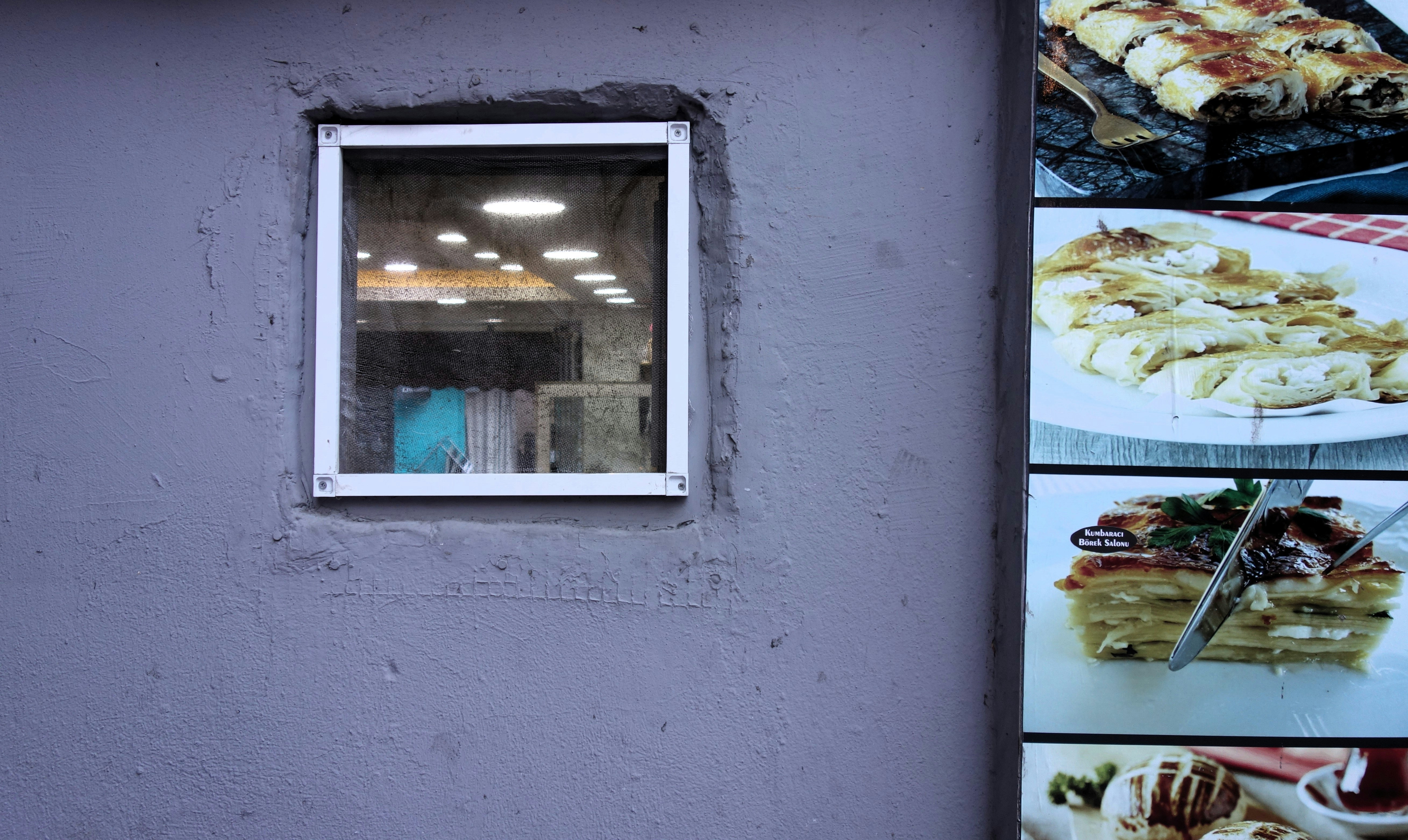 Window in a Purple Wall: A Quiet Glimpse into a Kitchen Window Display
