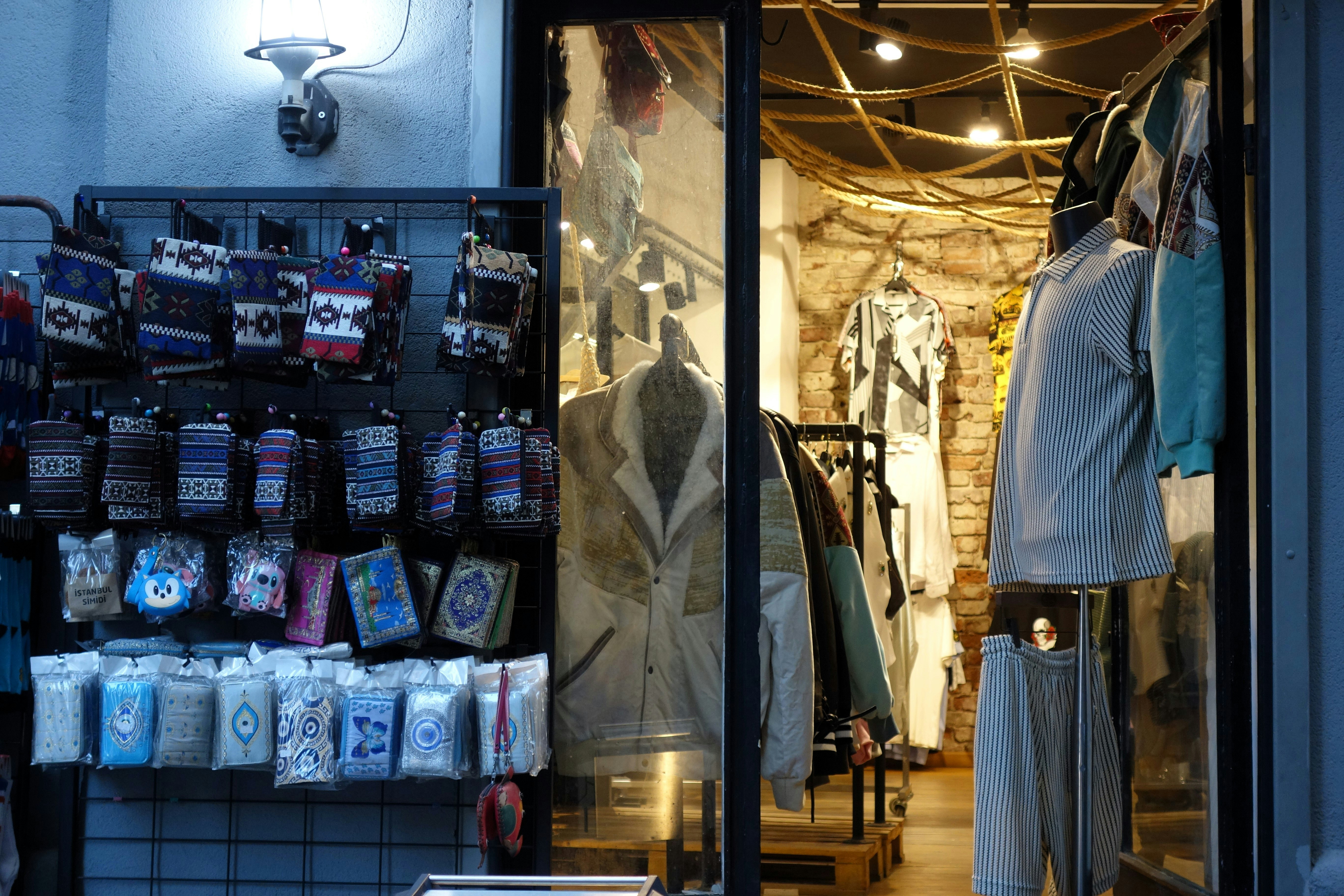 Neon-lit storefront wardrobe: a boutique doorway spilling into a cozy showroom