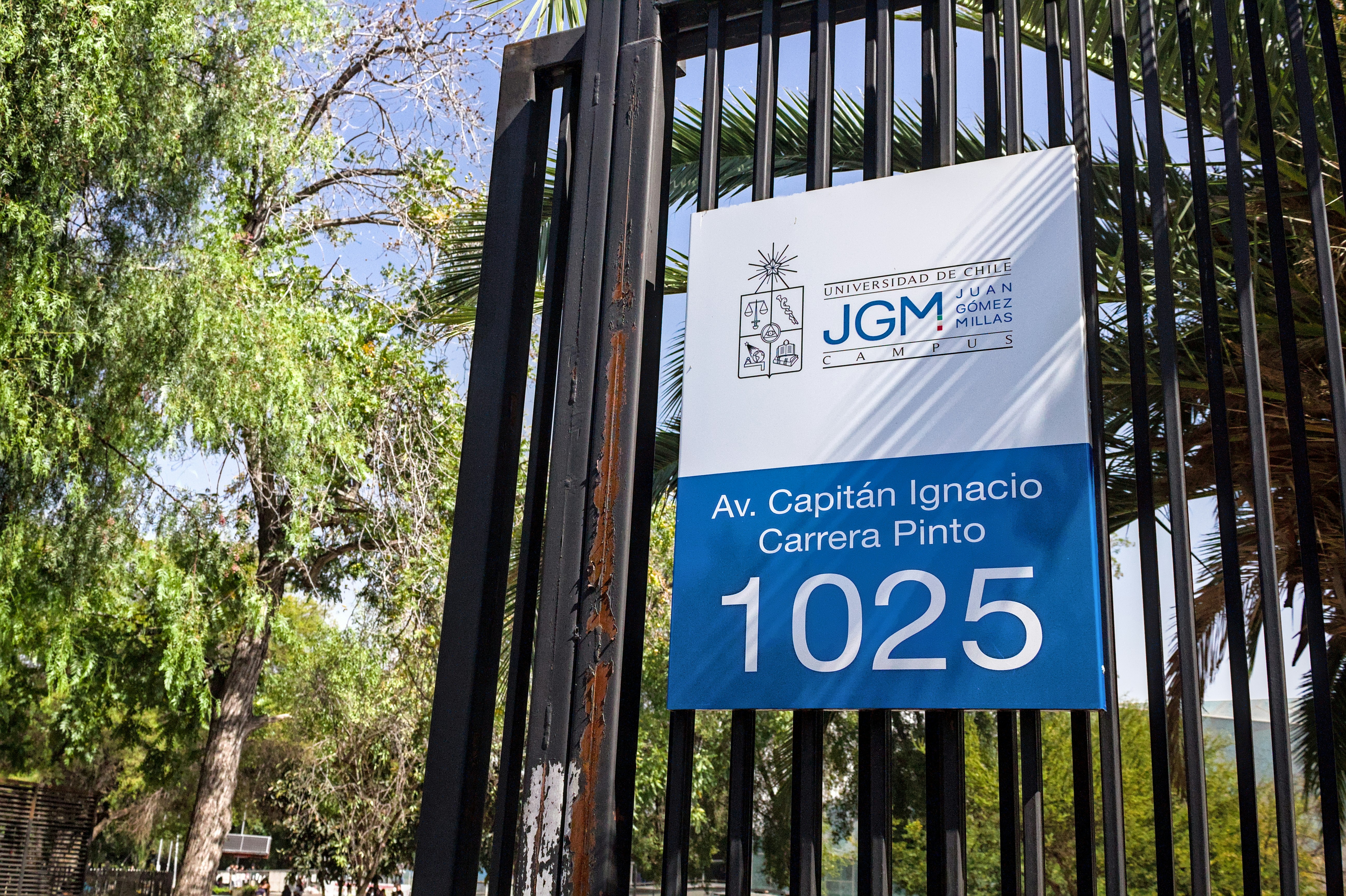 Gated Signpost at a Sunny University Entrance