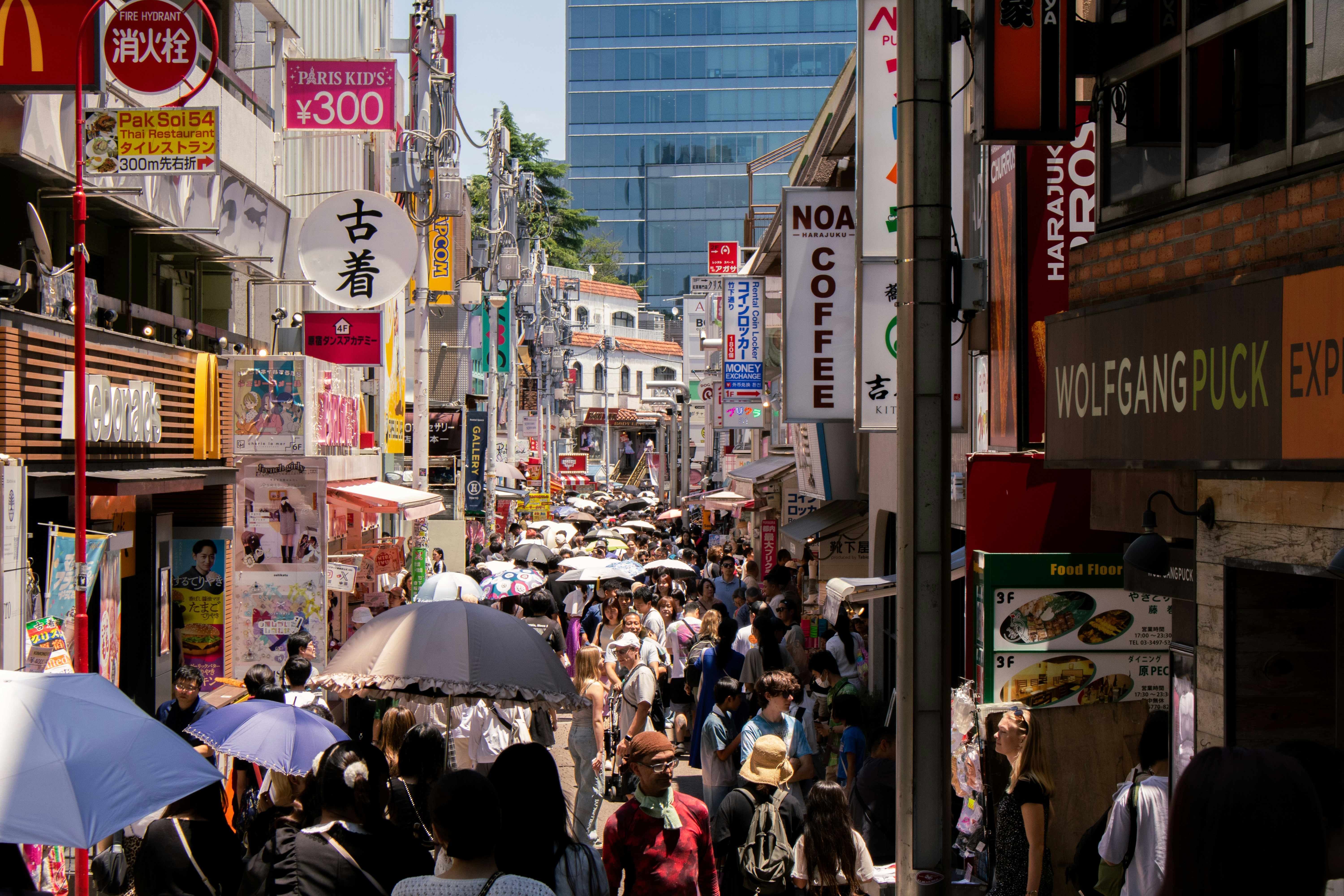 Bustling Nakamise-style street with a sea of umbrellas