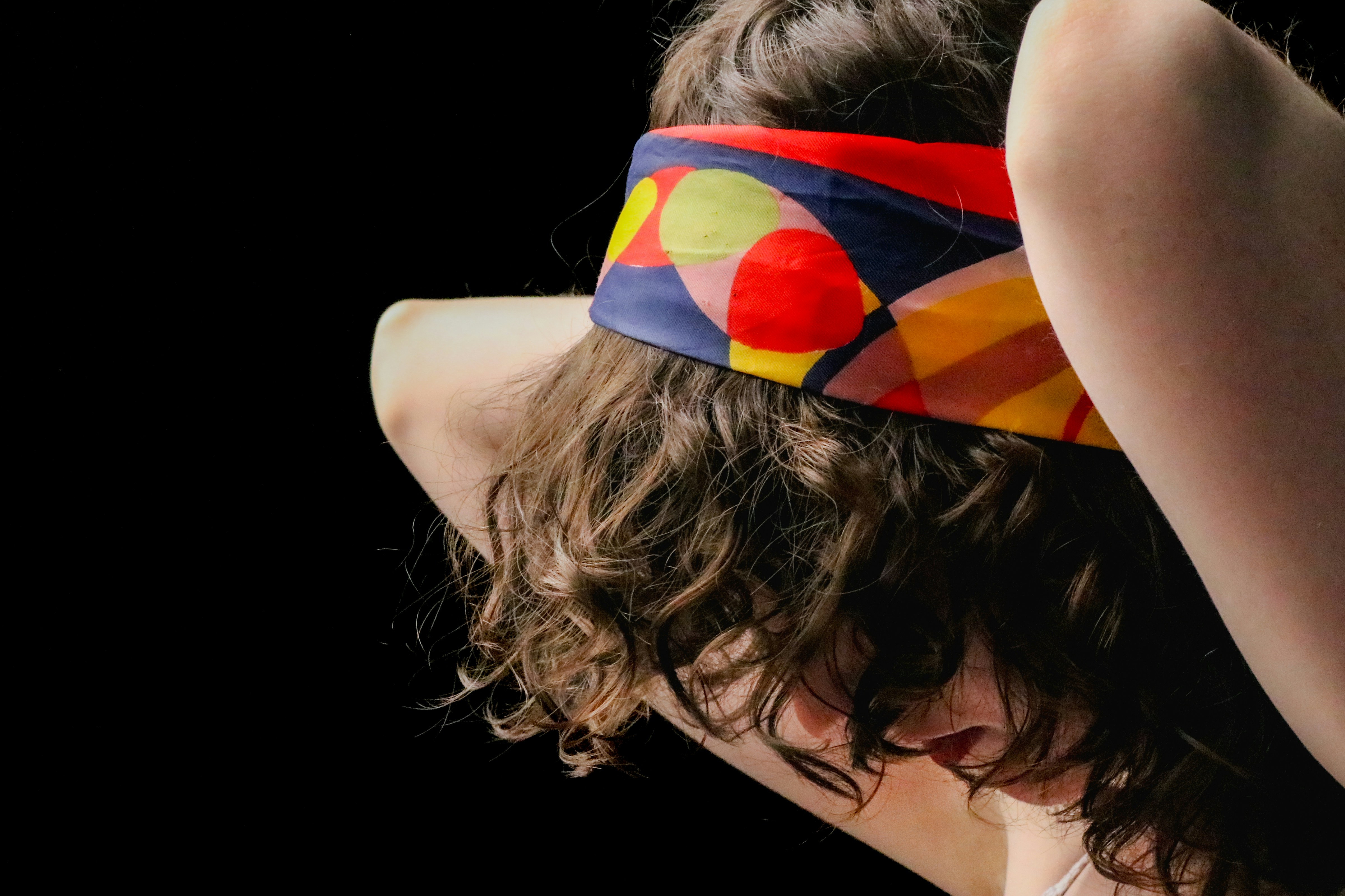 Headband Colors Against Darkness: A Portrait in Shadow
