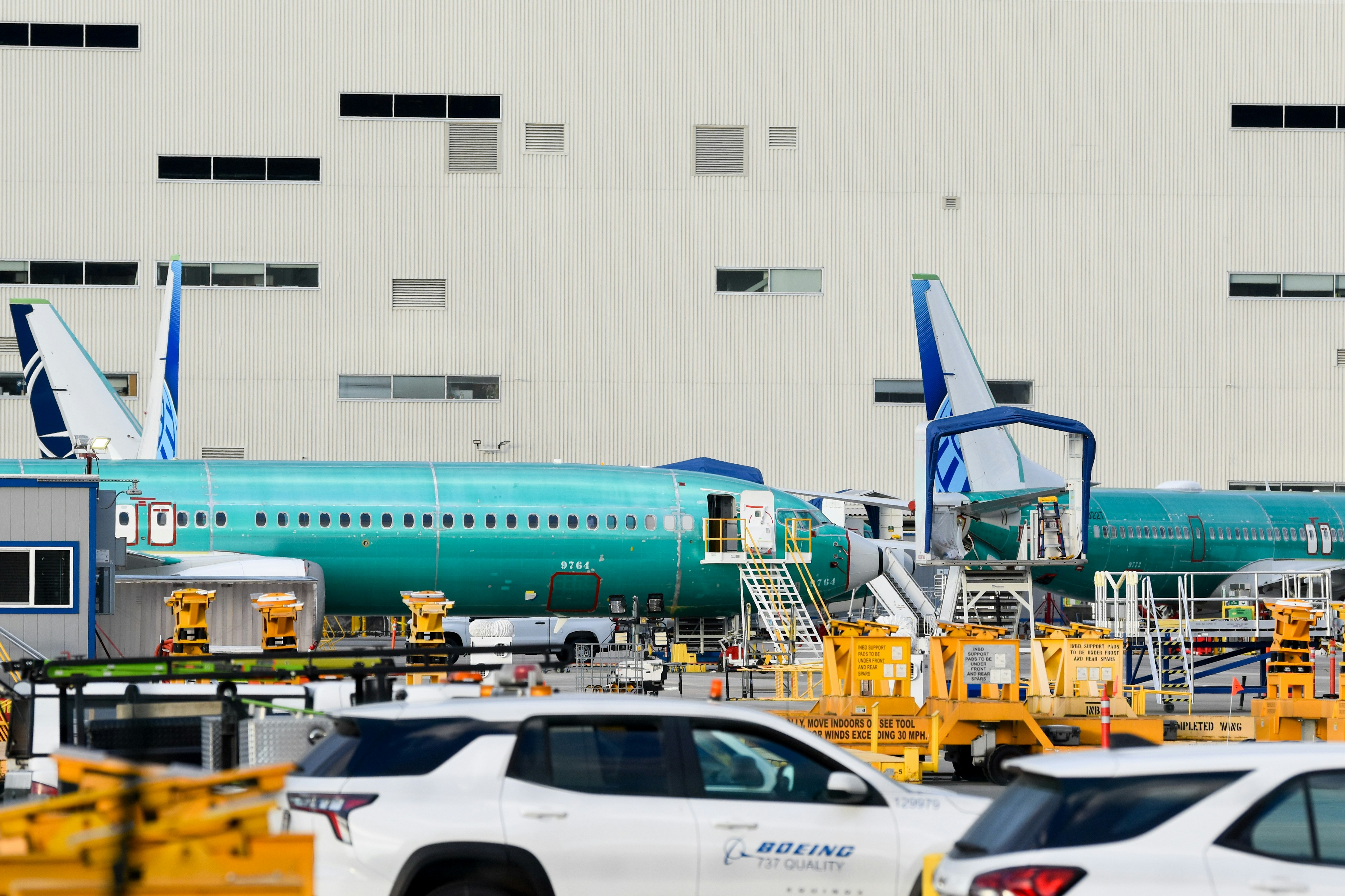 Grounded Giants: Turquoise Airframes Rest at the Gate
