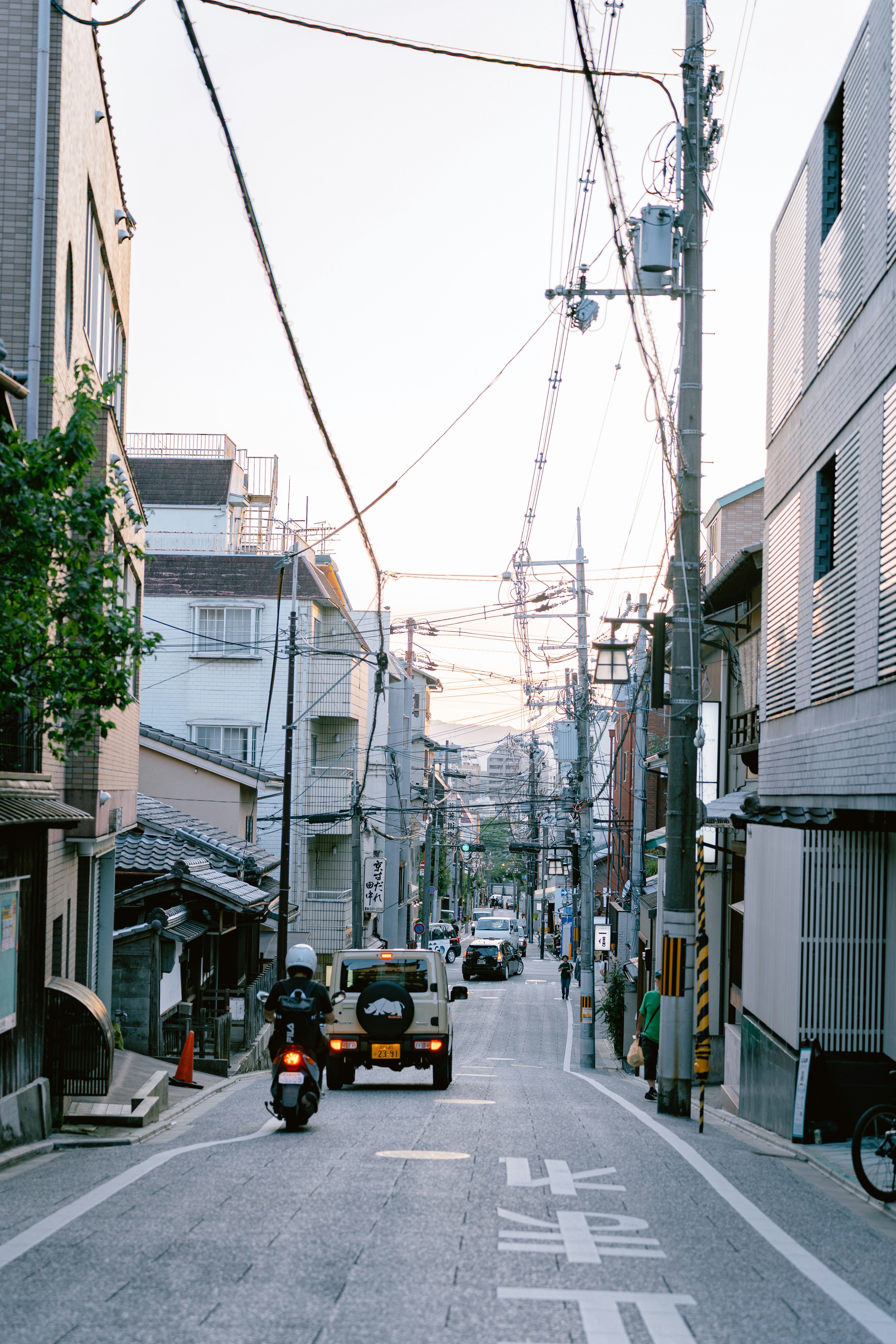 Urban Convergence: A Quiet Street Where Power Lines Meet Progress