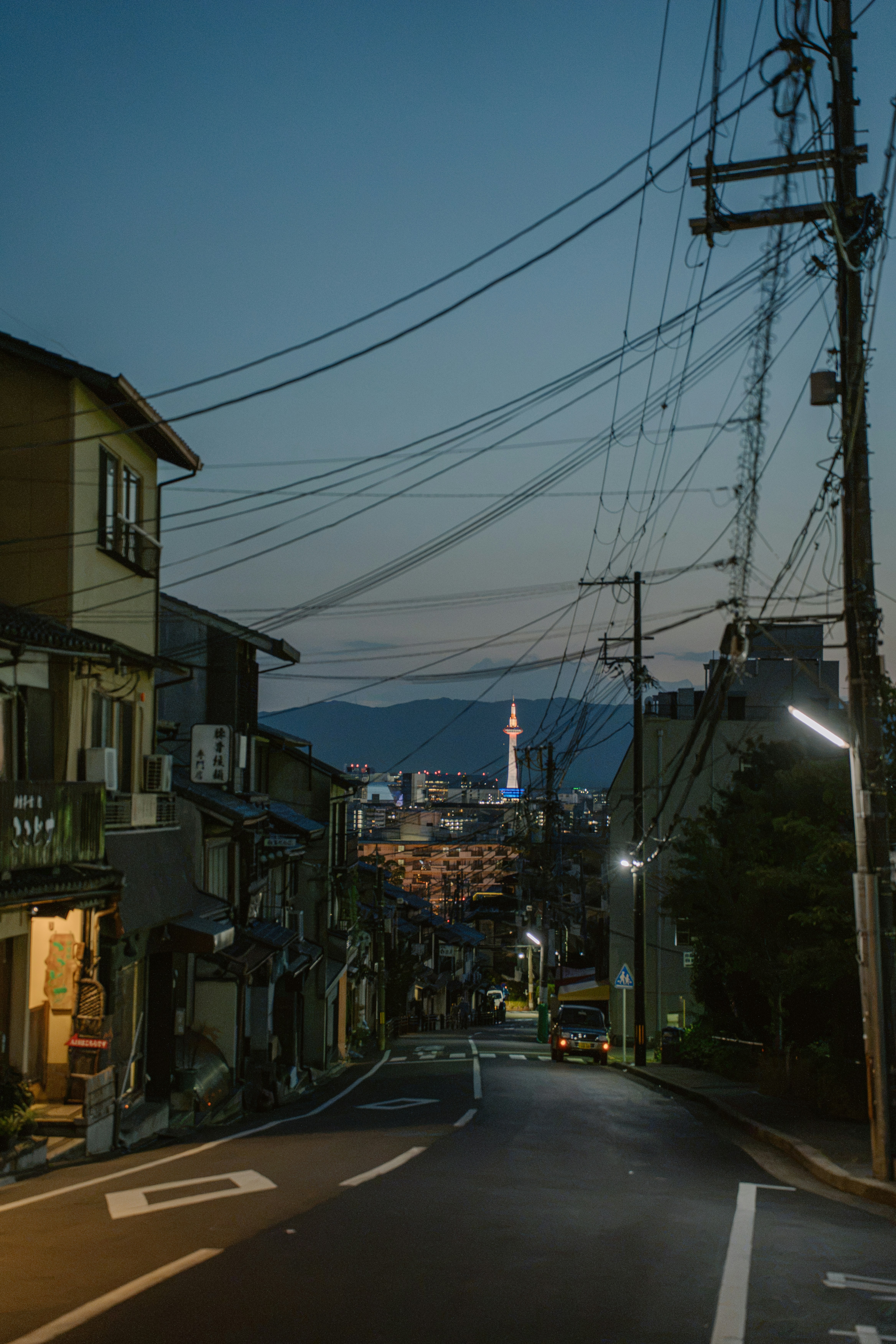 Evening Avenue: Distant Skyline Emerges Beyond a Quiet Japanese Street