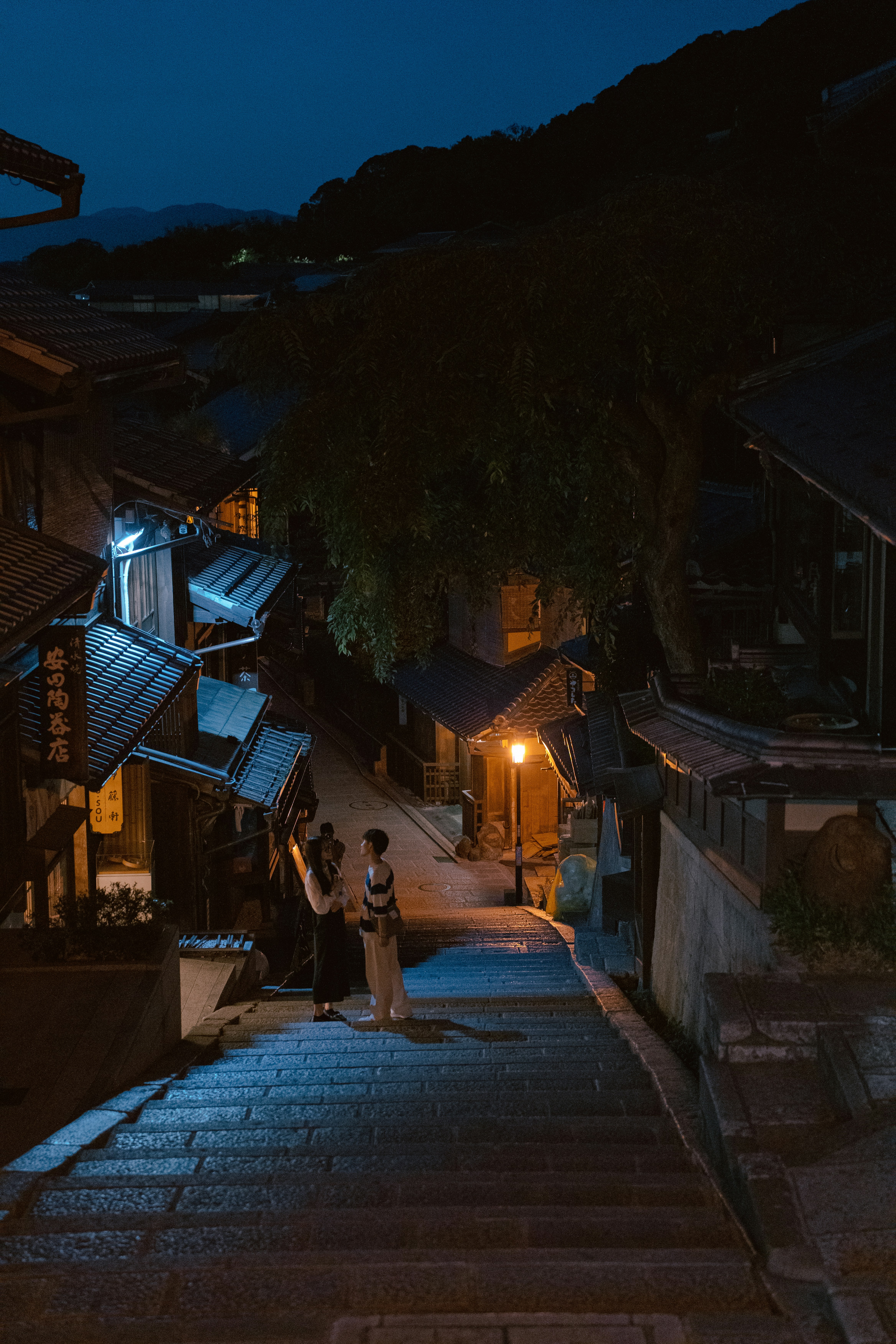 Moonlit steps: a quiet village night near the lanterns