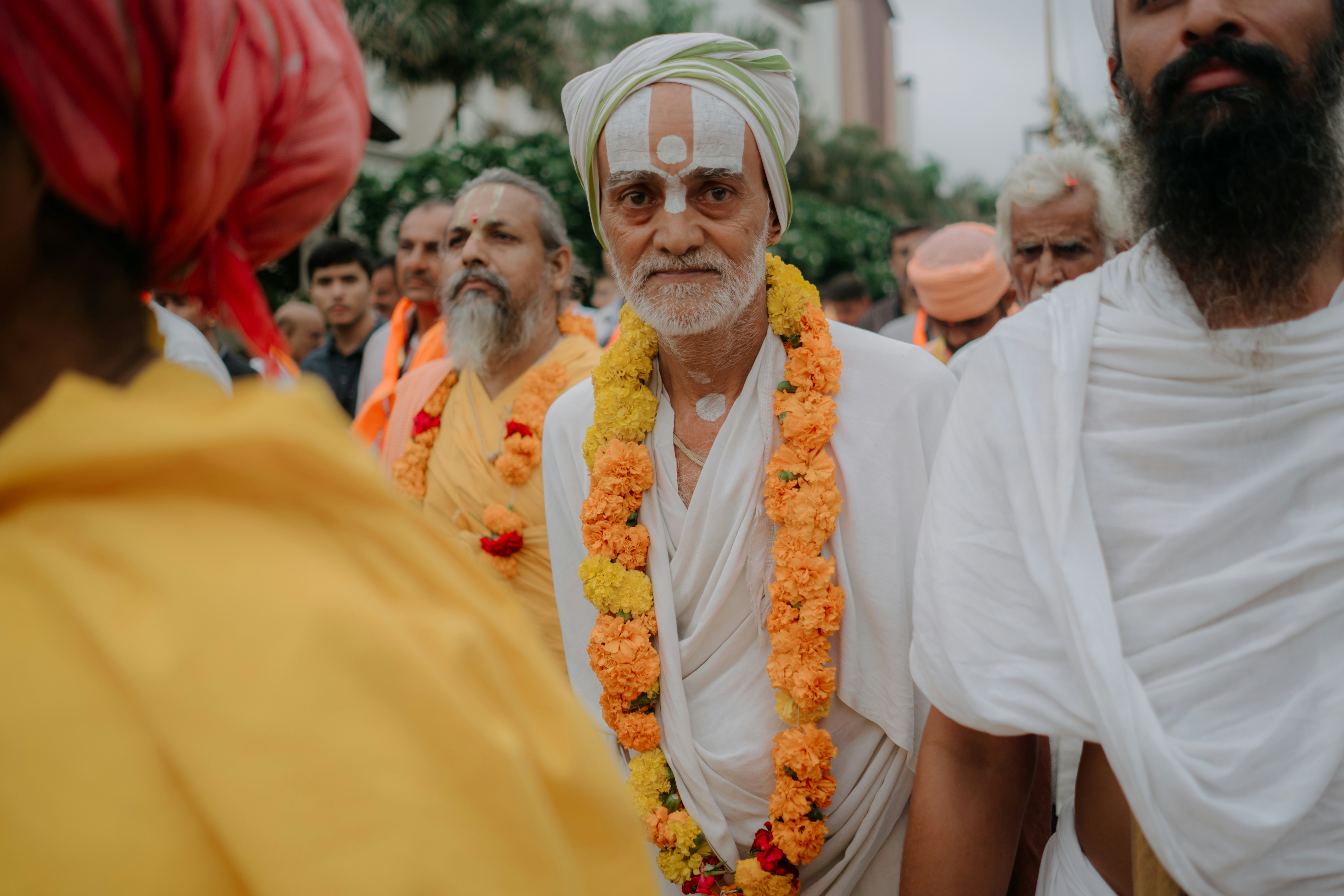 Center of Reverence: Elder with Tilaka Amid a Festive Grove