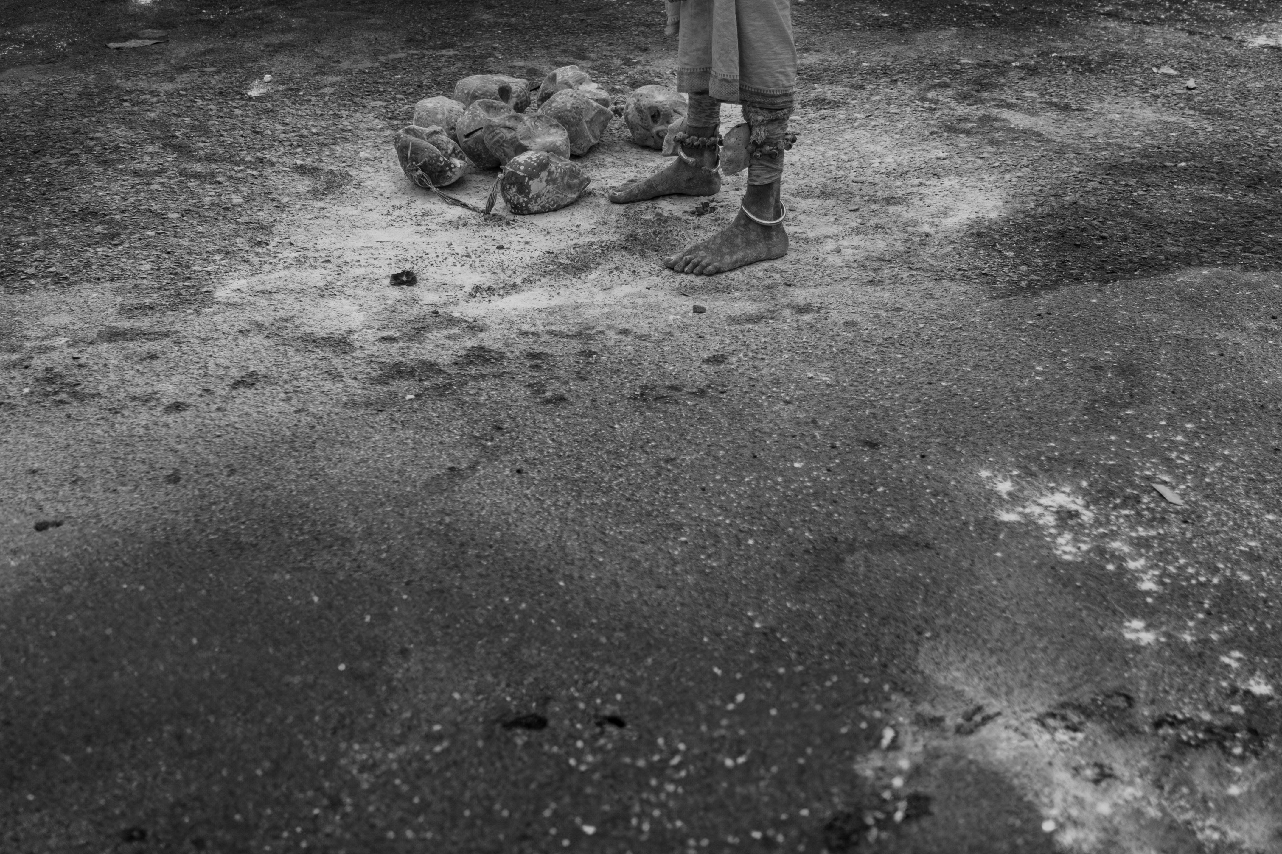 Booted silhouette over a rough, cratered ground