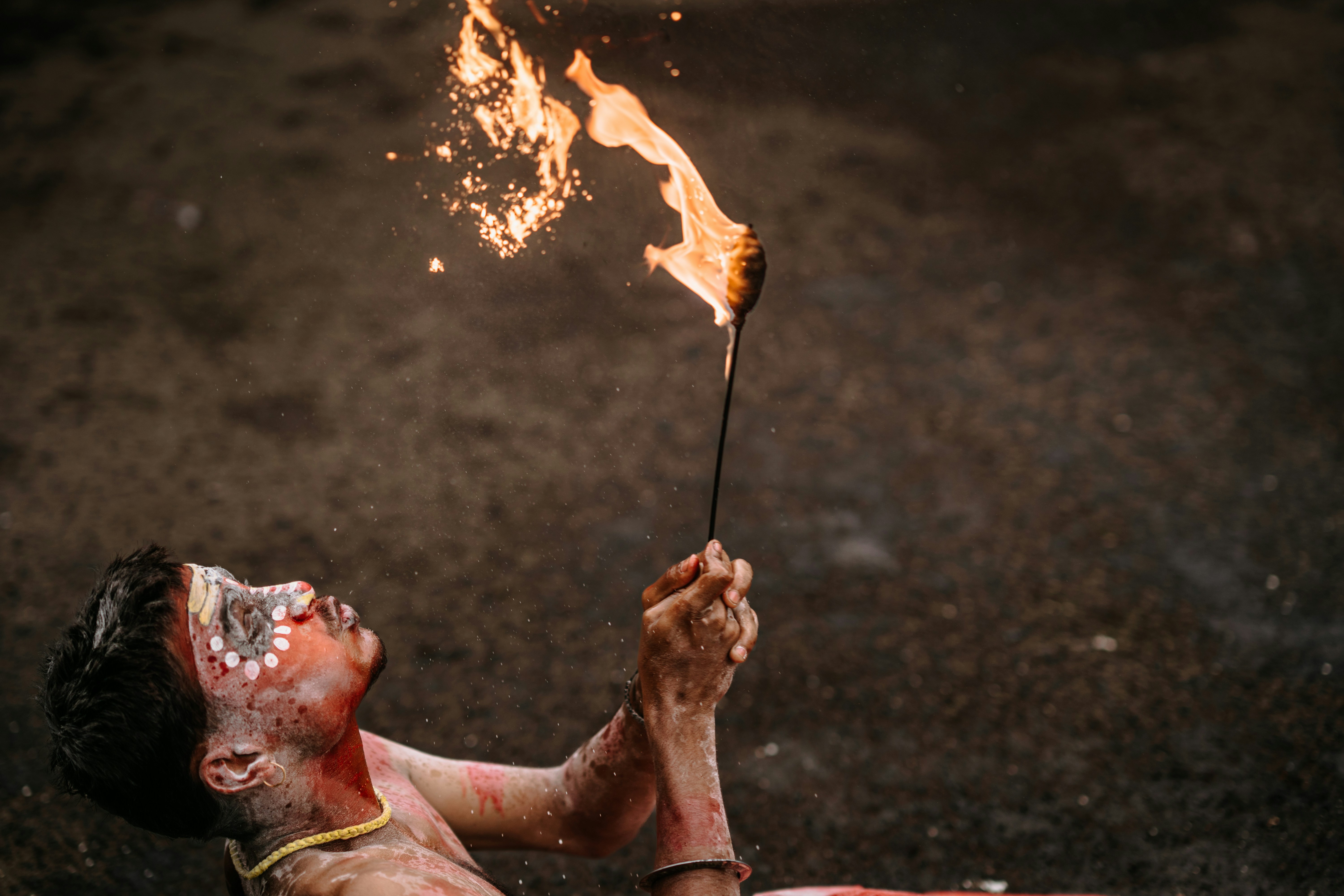 Flame Rite: A Fire-Twirler in a Darkened Ground