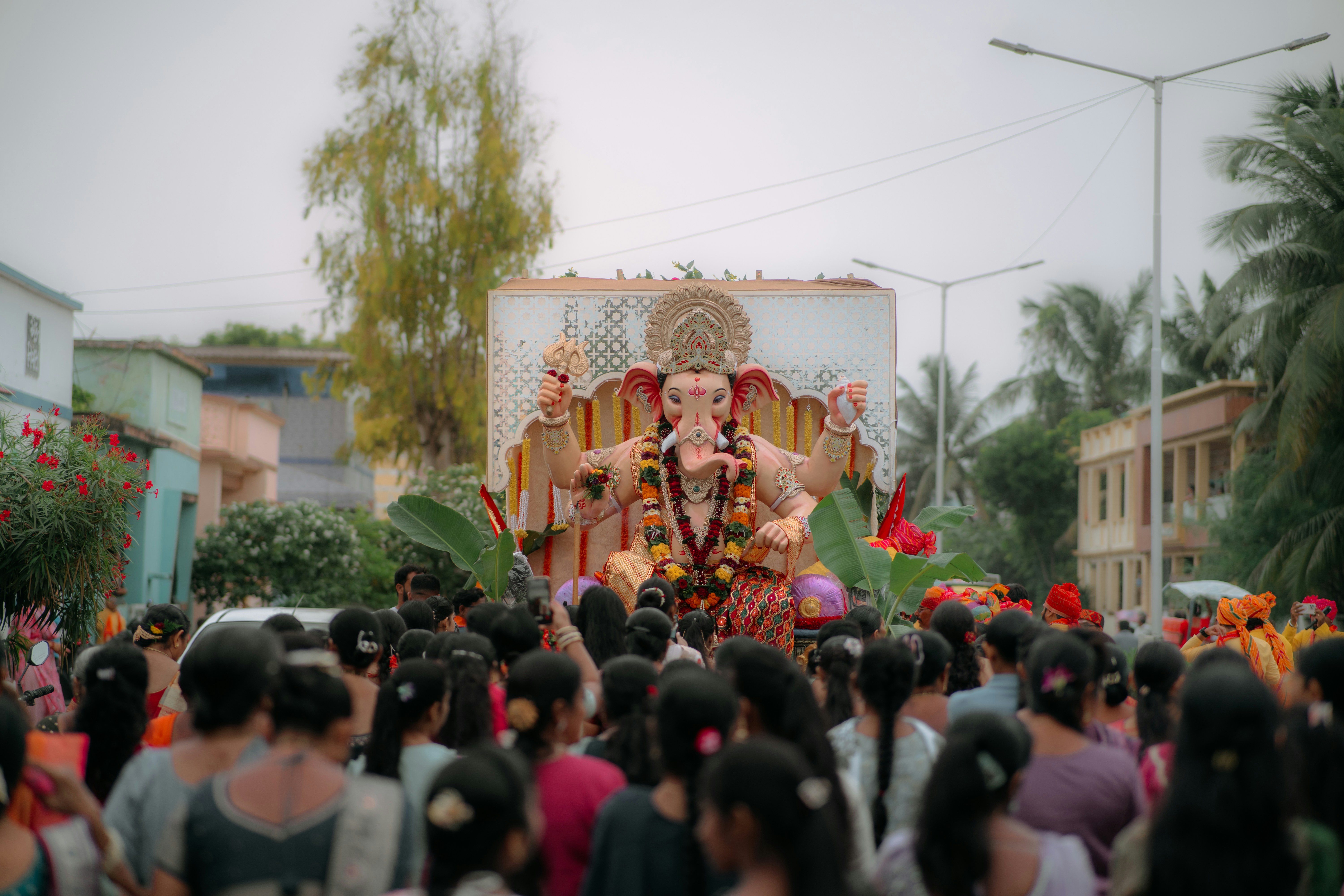 Procession Under a Grand Ganesha Rider: Crowds Await the Murti