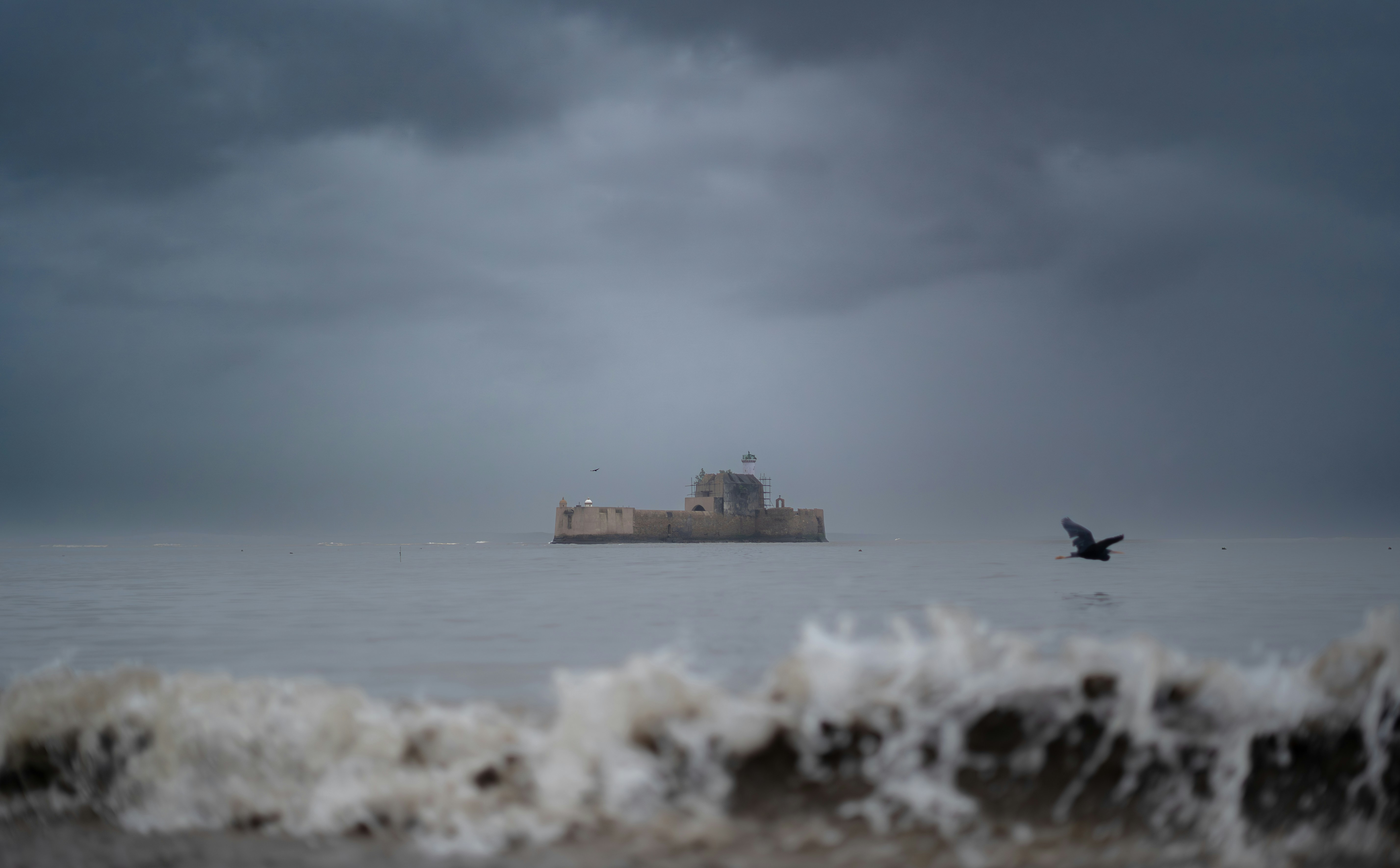 Fortress on the Horizon: A Distant Sentinel among Rolling Waves