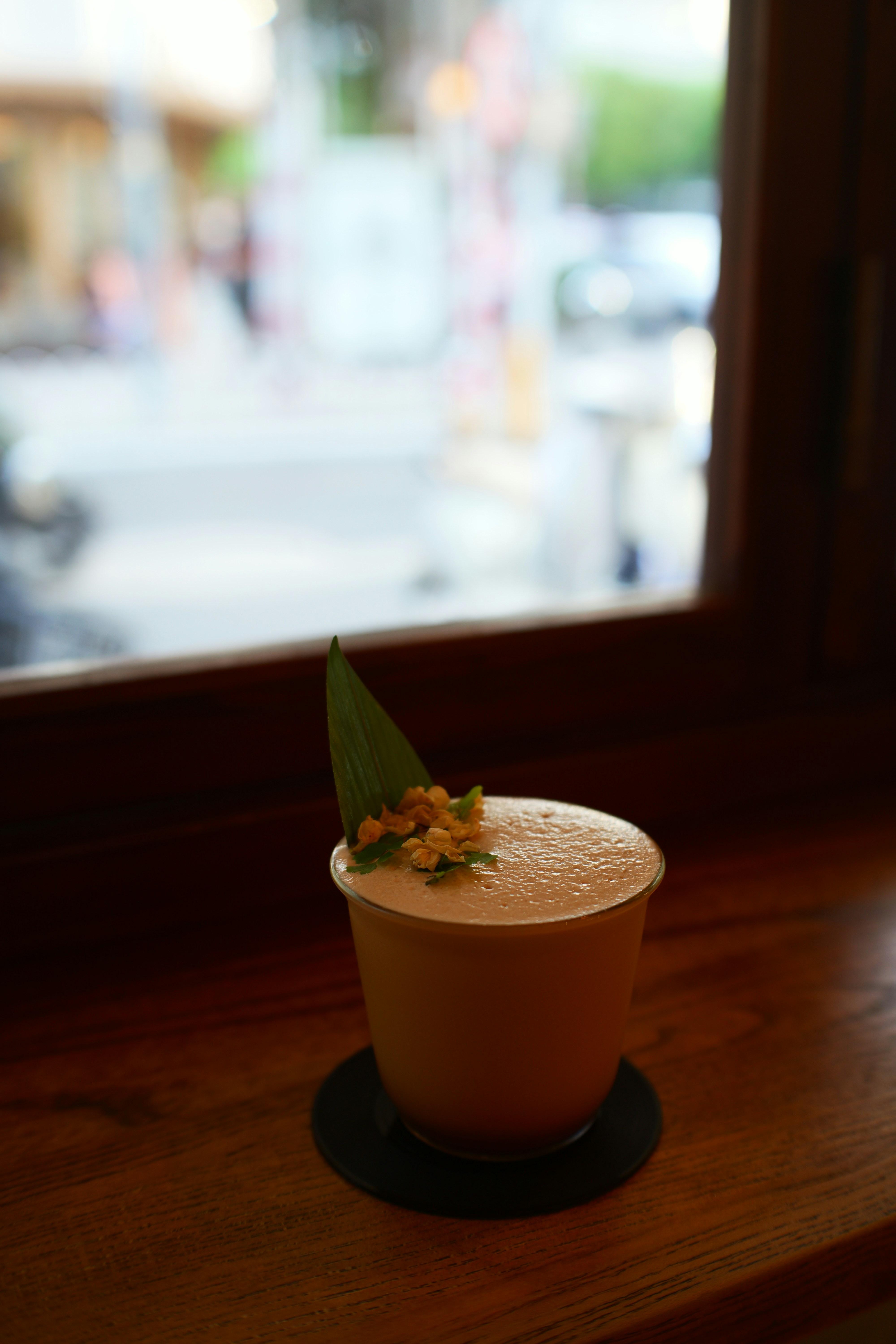 A Quiet Cup: Citrus Foam on a Wooden Window Sill